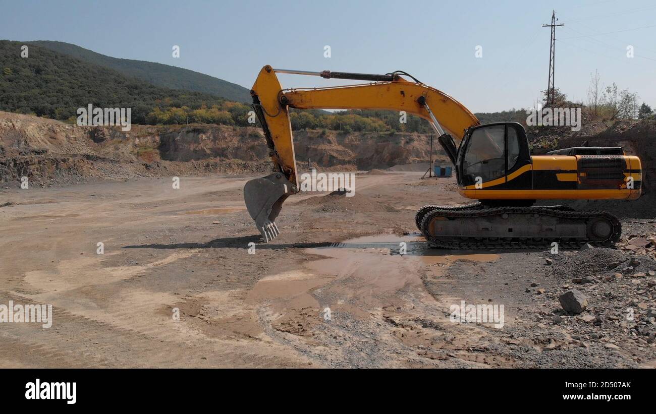 Yellow digger machine. Excavator with a shovel for digging. Sand and ...