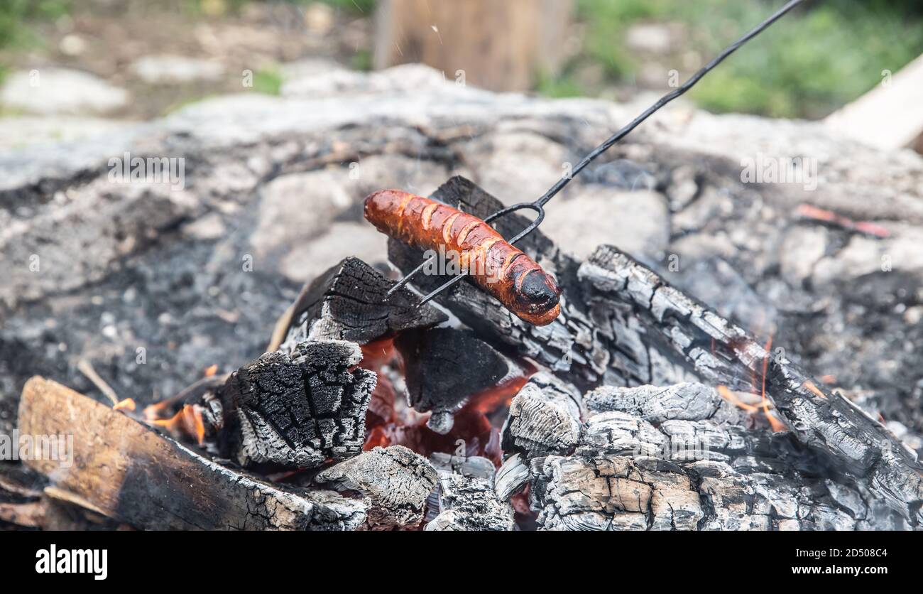 Sausage roasted over an almost extinguished fire Stock Photo - Alamy