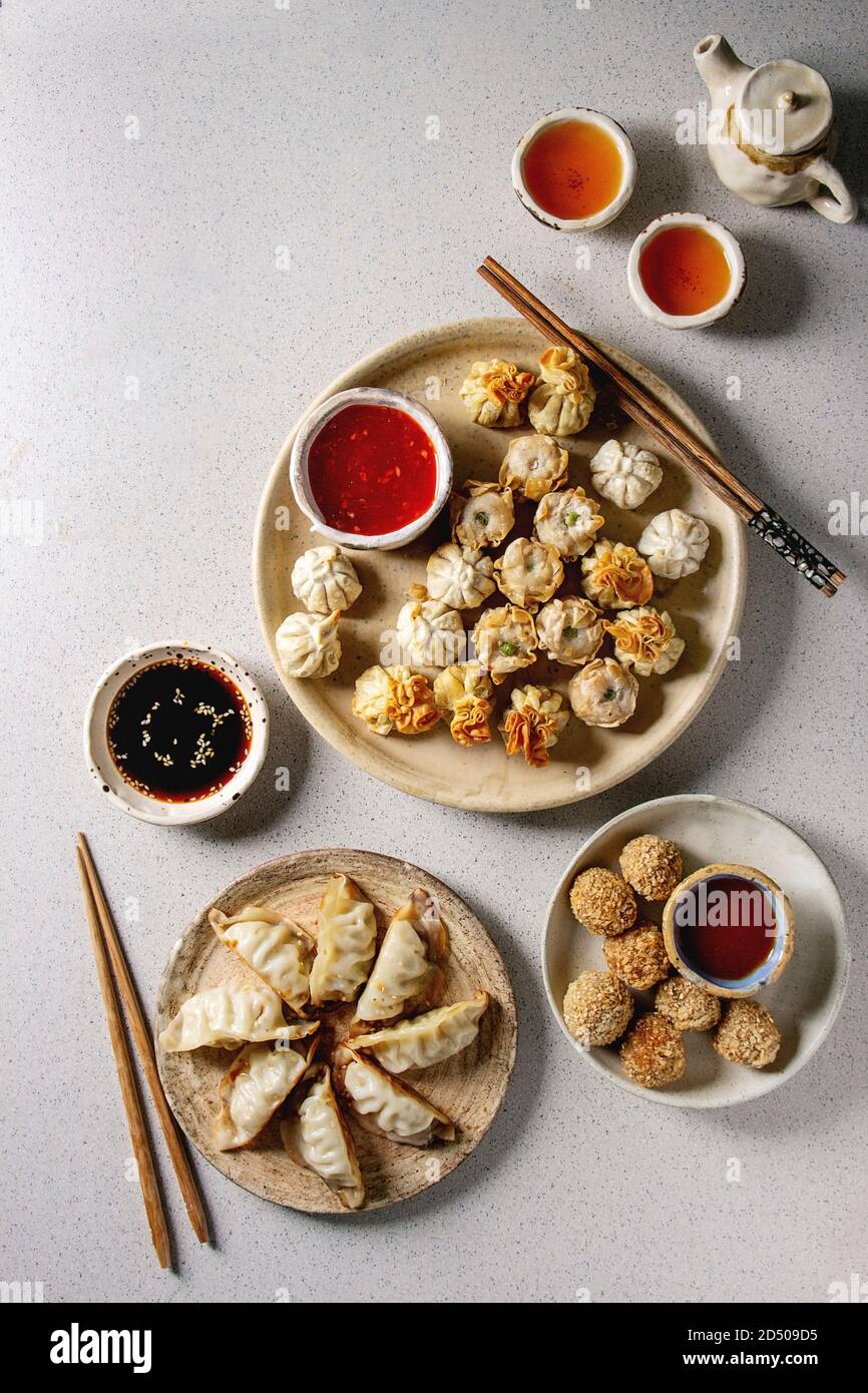 Dim sum Gyozas asian fried dumplings party set with variety of sauces ...