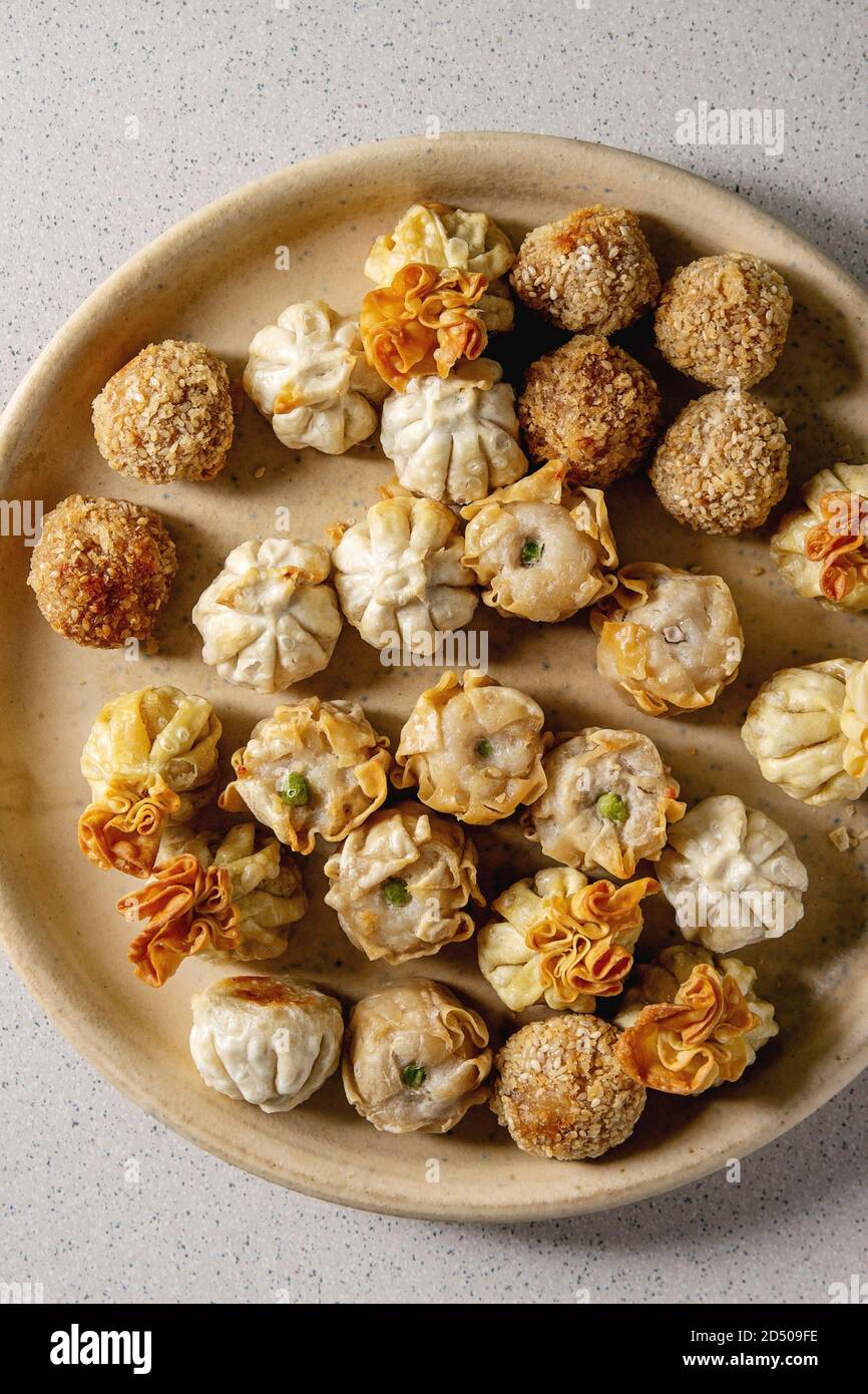 Dim sum Gyozas asian fried dumplings party set in ceramic plate over ...