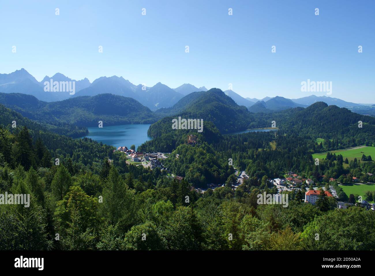 View of Bavaria countryside with rolling mountains, trees, and Lake ...