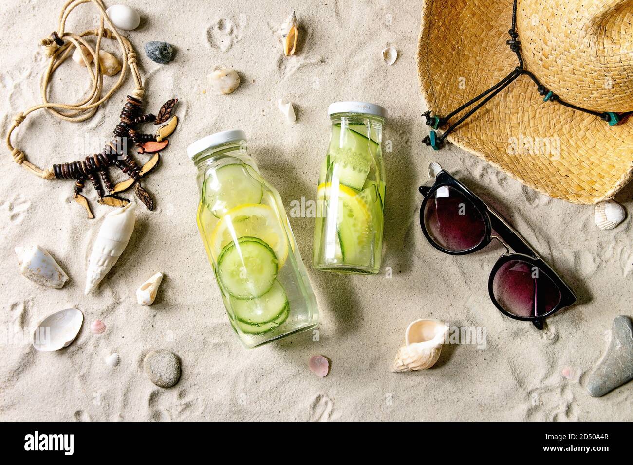 Summer theme. Two glass bottles with lemon and cucumber infusion sassy ...