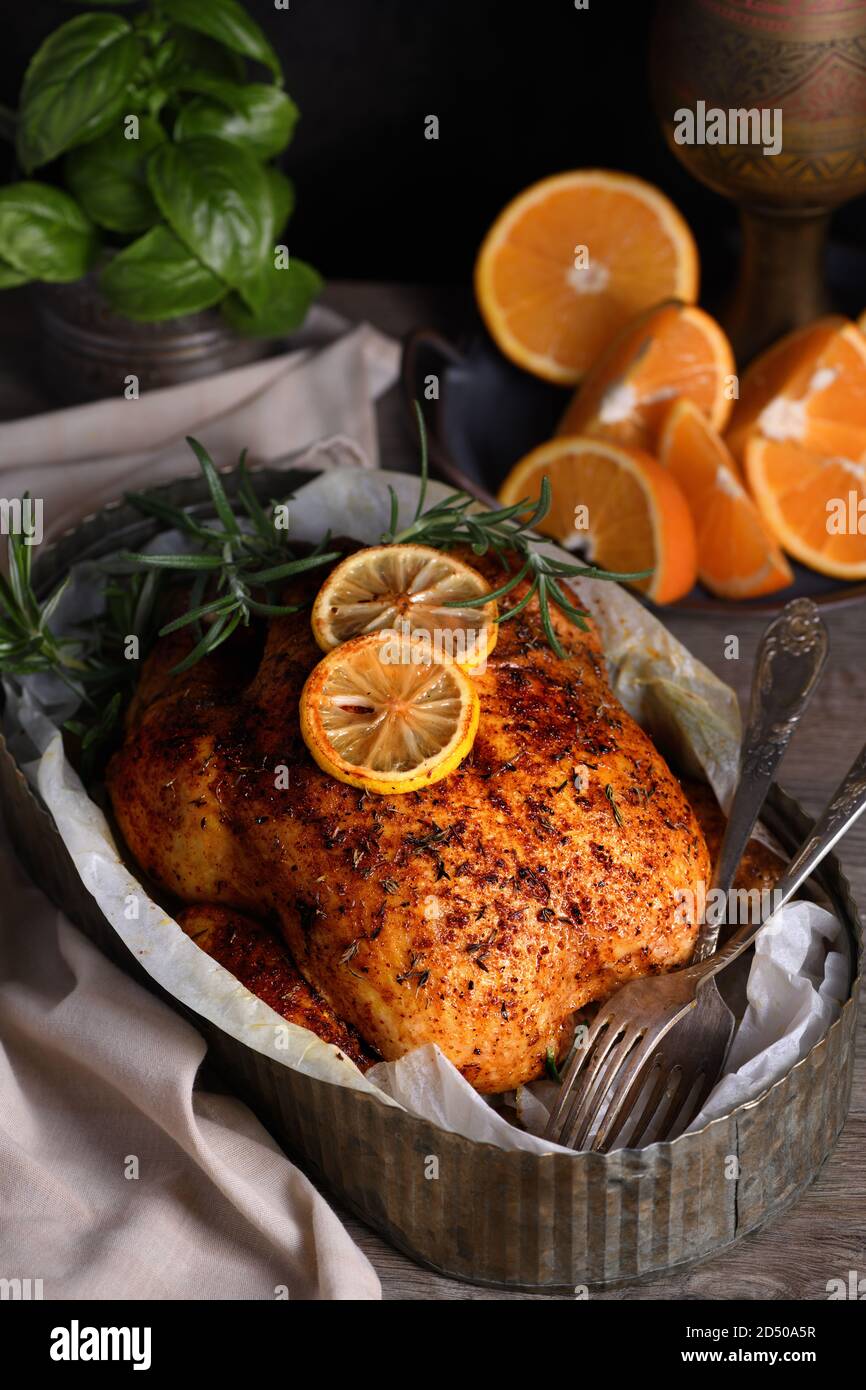 Baked whole chicken in spices with crispy appetizing fried crust in a ...
