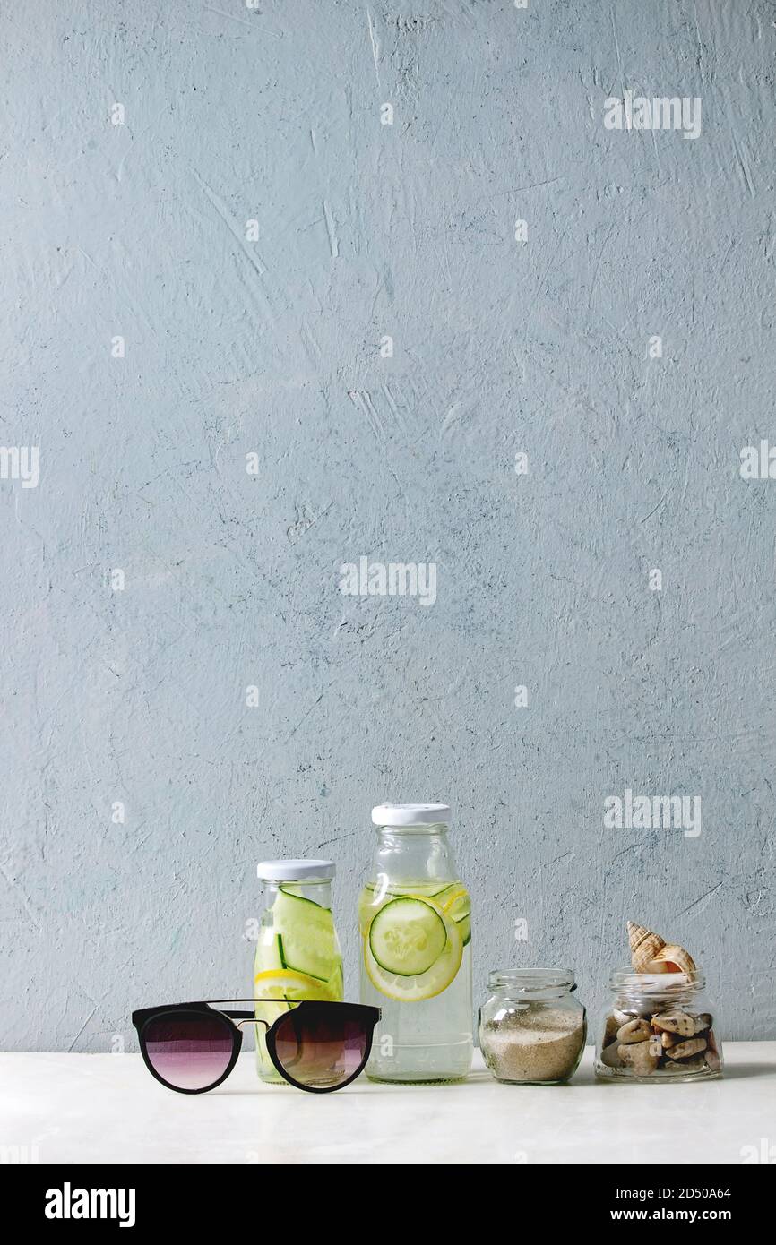 Summer theme. Two glass bottles with lemon and cucumber infusion sassy ...