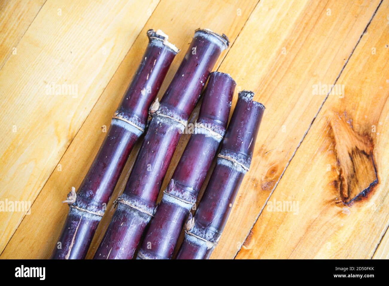 Sugar cane on wooden table background Stock Photo - Alamy