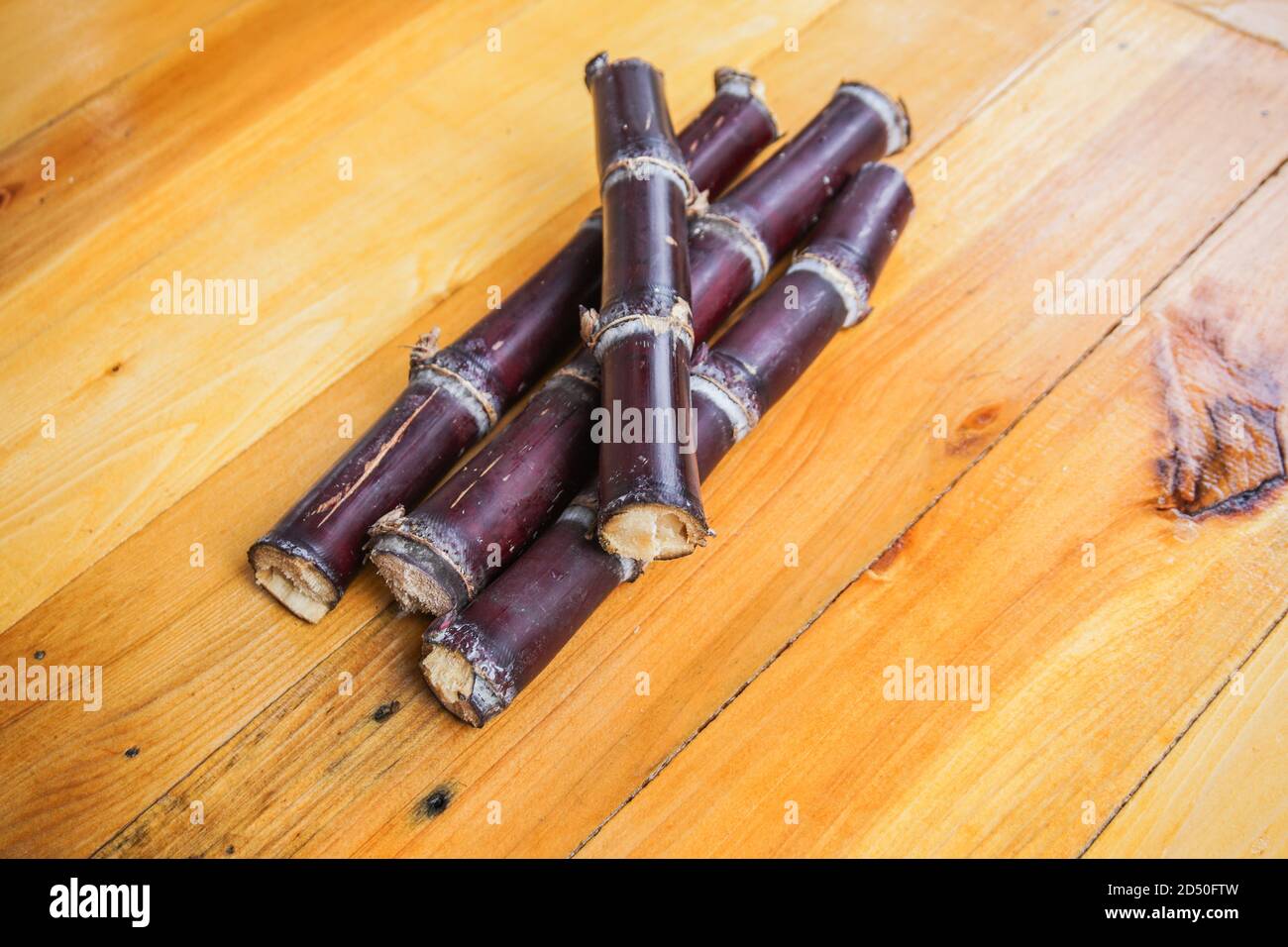 Sugar cane on wooden table background Stock Photo - Alamy