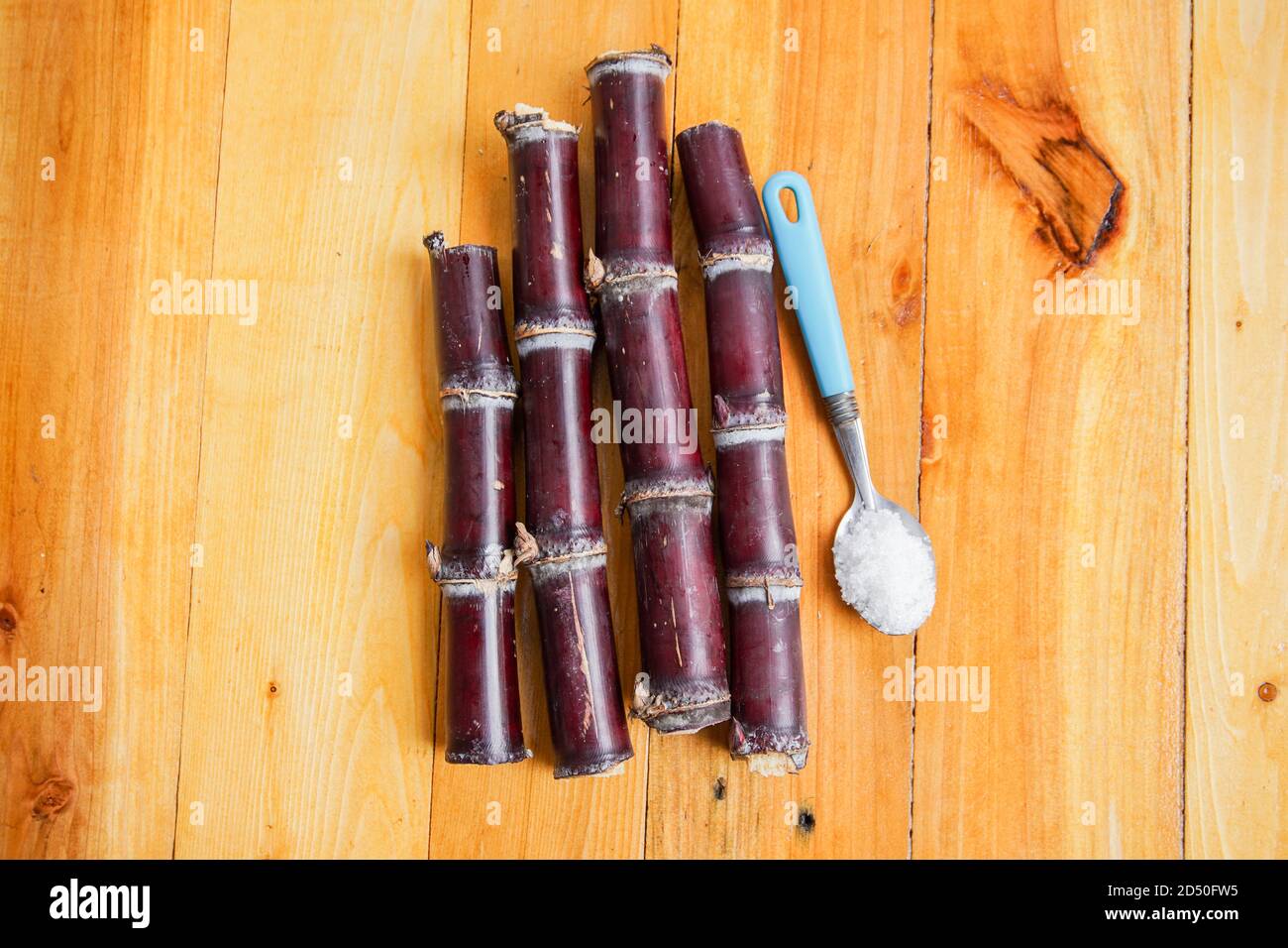 Sugar cane on wooden table background Stock Photo - Alamy
