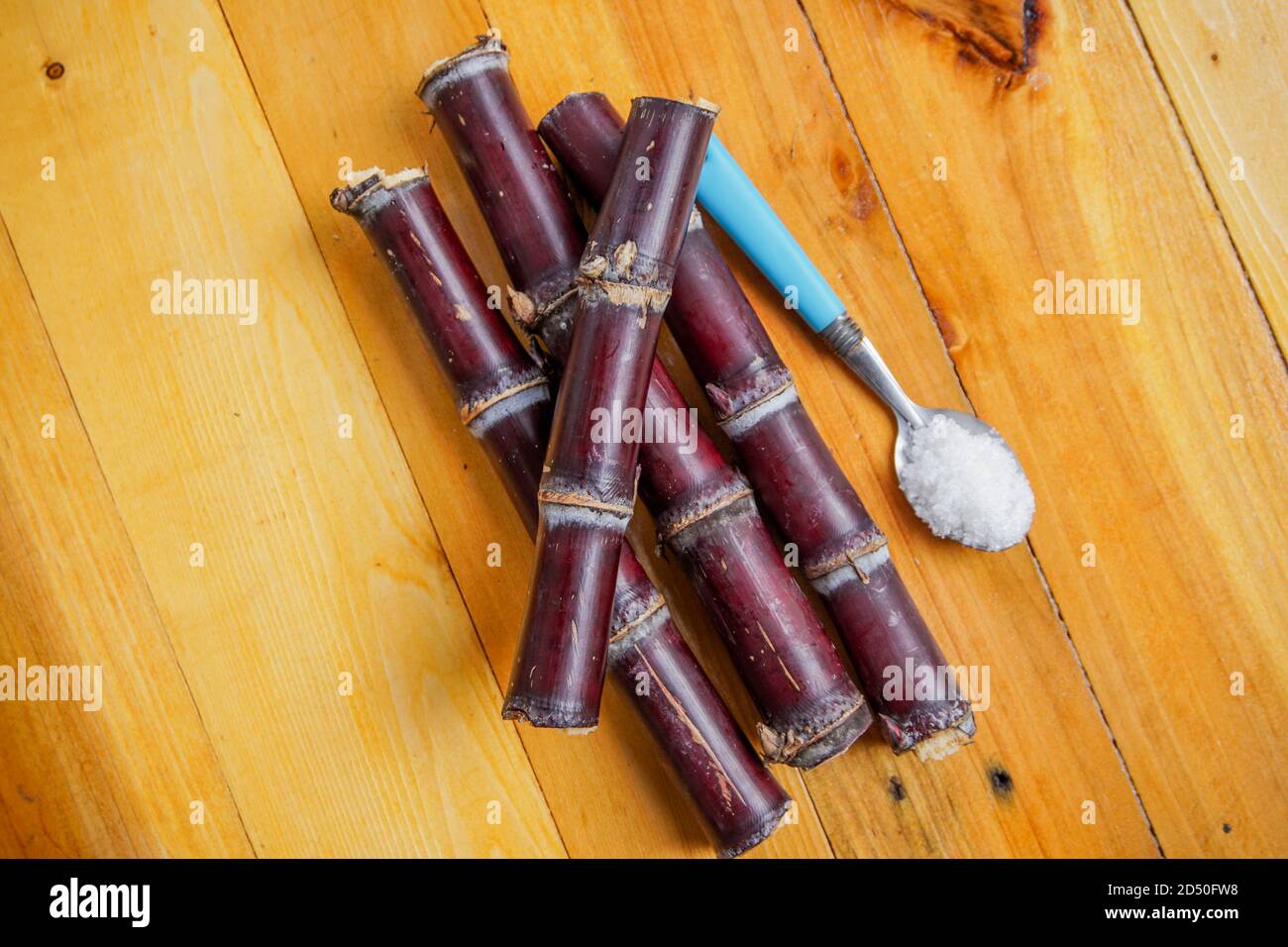 Sugar cane on wooden table background Stock Photo - Alamy