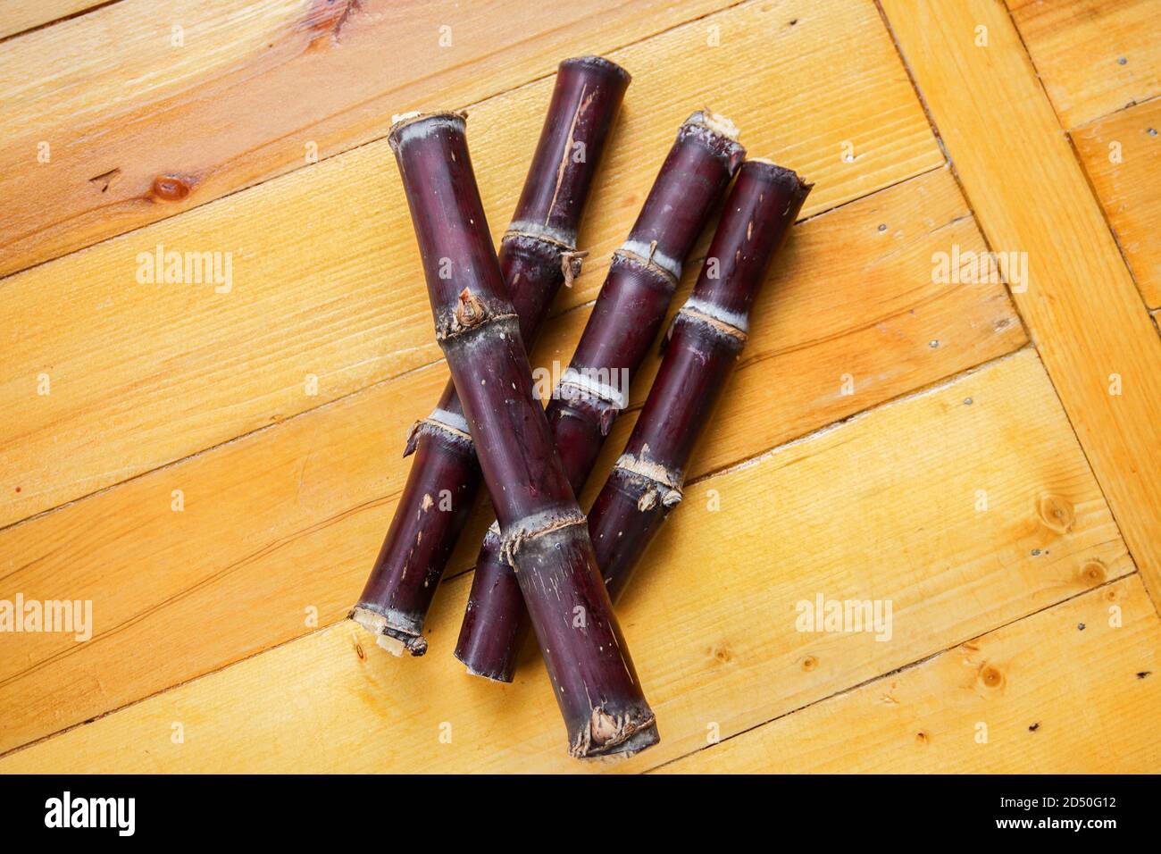 Sugar cane on wooden table background Stock Photo - Alamy
