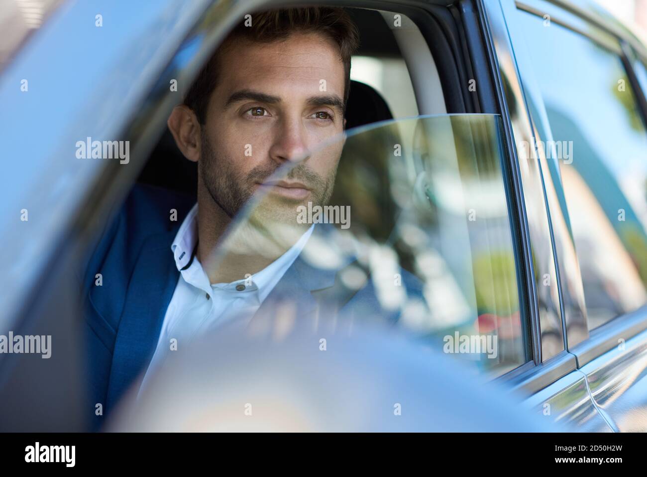 Man driving through the city in his car Stock Photo - Alamy