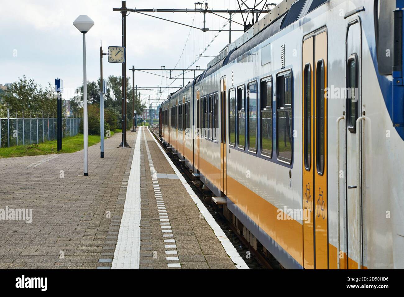 Railway station with passanger train Stock Photo - Alamy