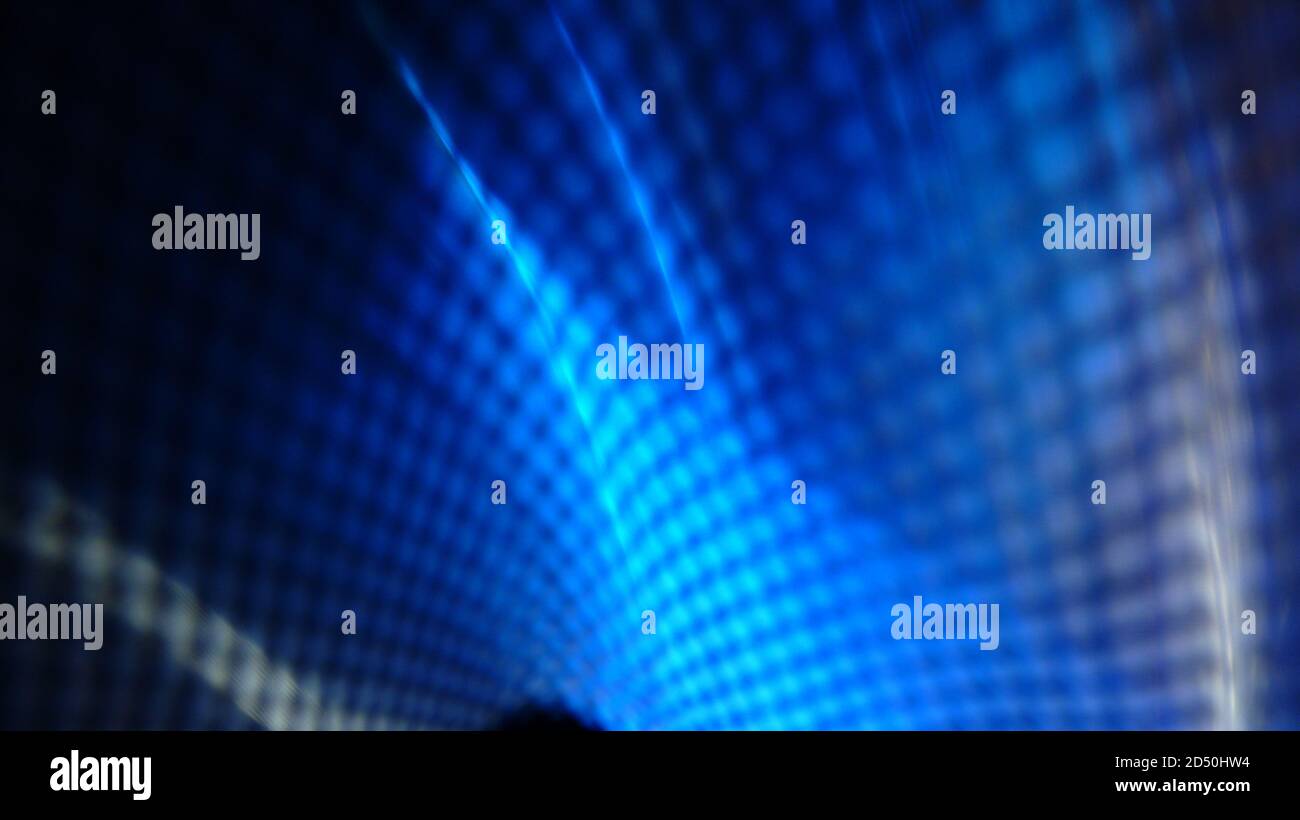 Progressive rhythmic blue shaded light layers seen through a net fence ...