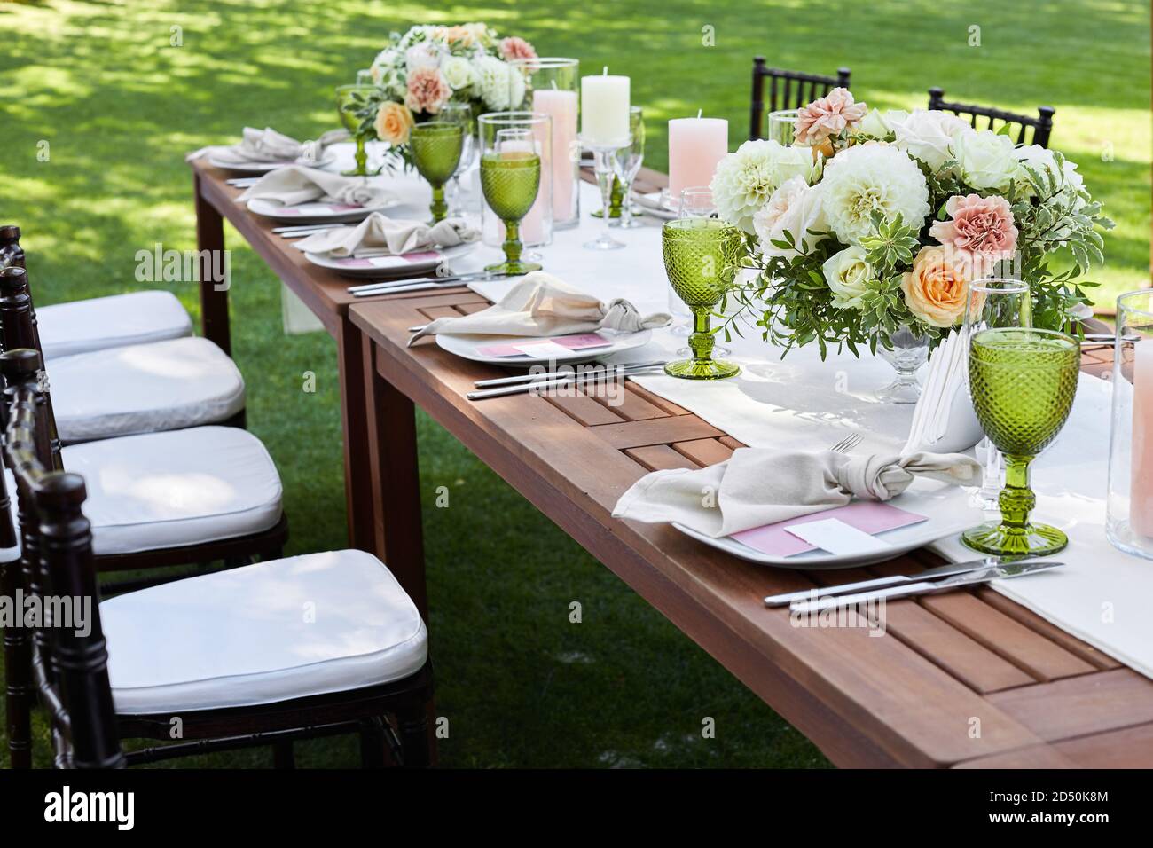 dinner tables with white cloth, served with porcelain and green glasses ...