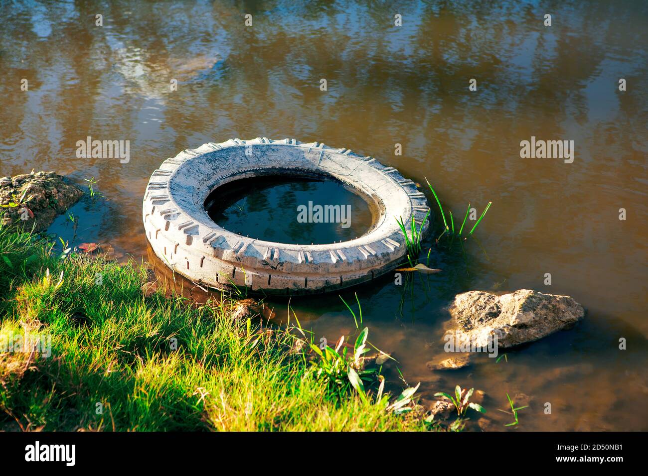 Truck tire in the river water. Environmental pollution concept Stock ...