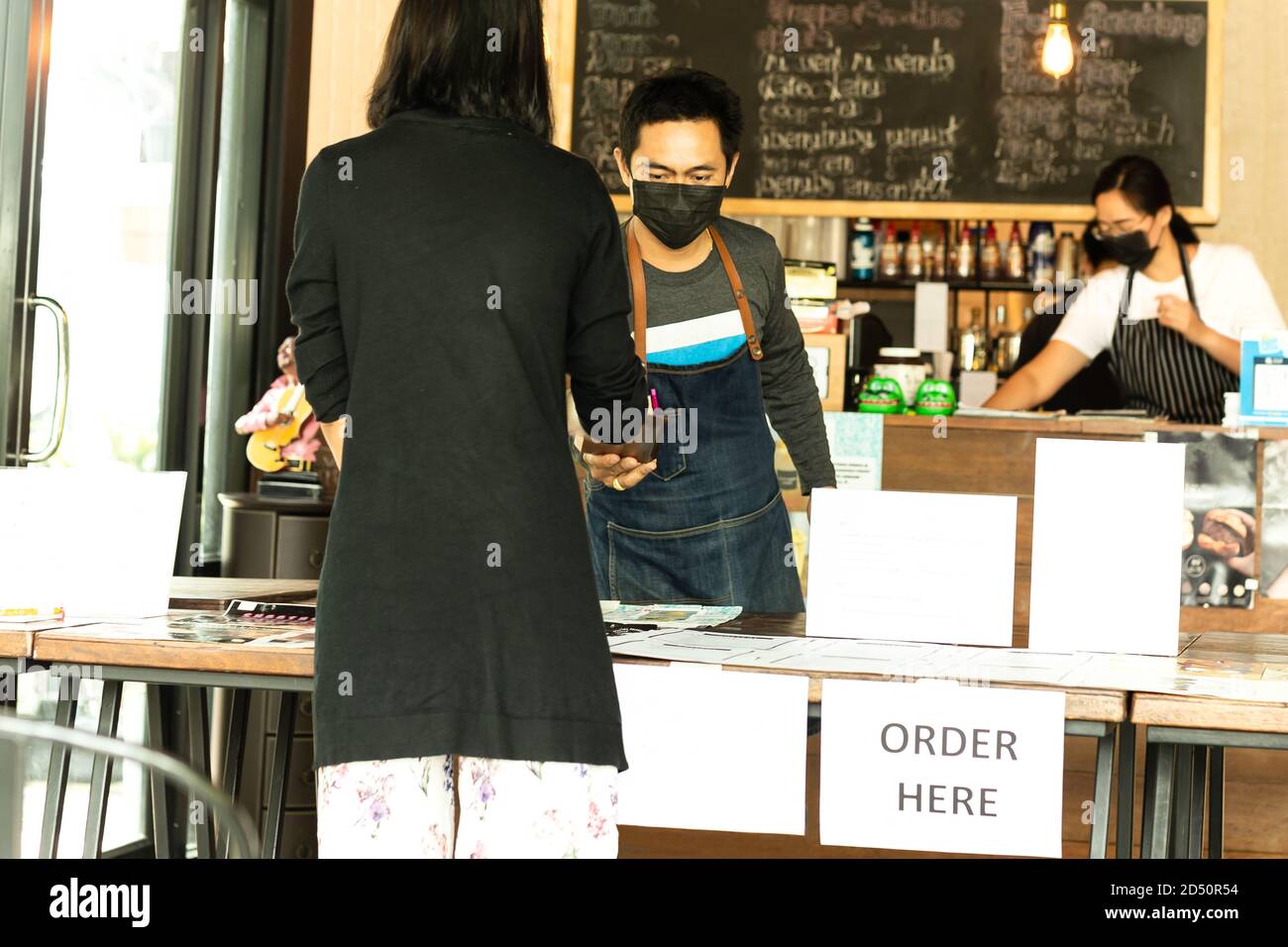 Social distance conceptual small business waiter serving customer in ...