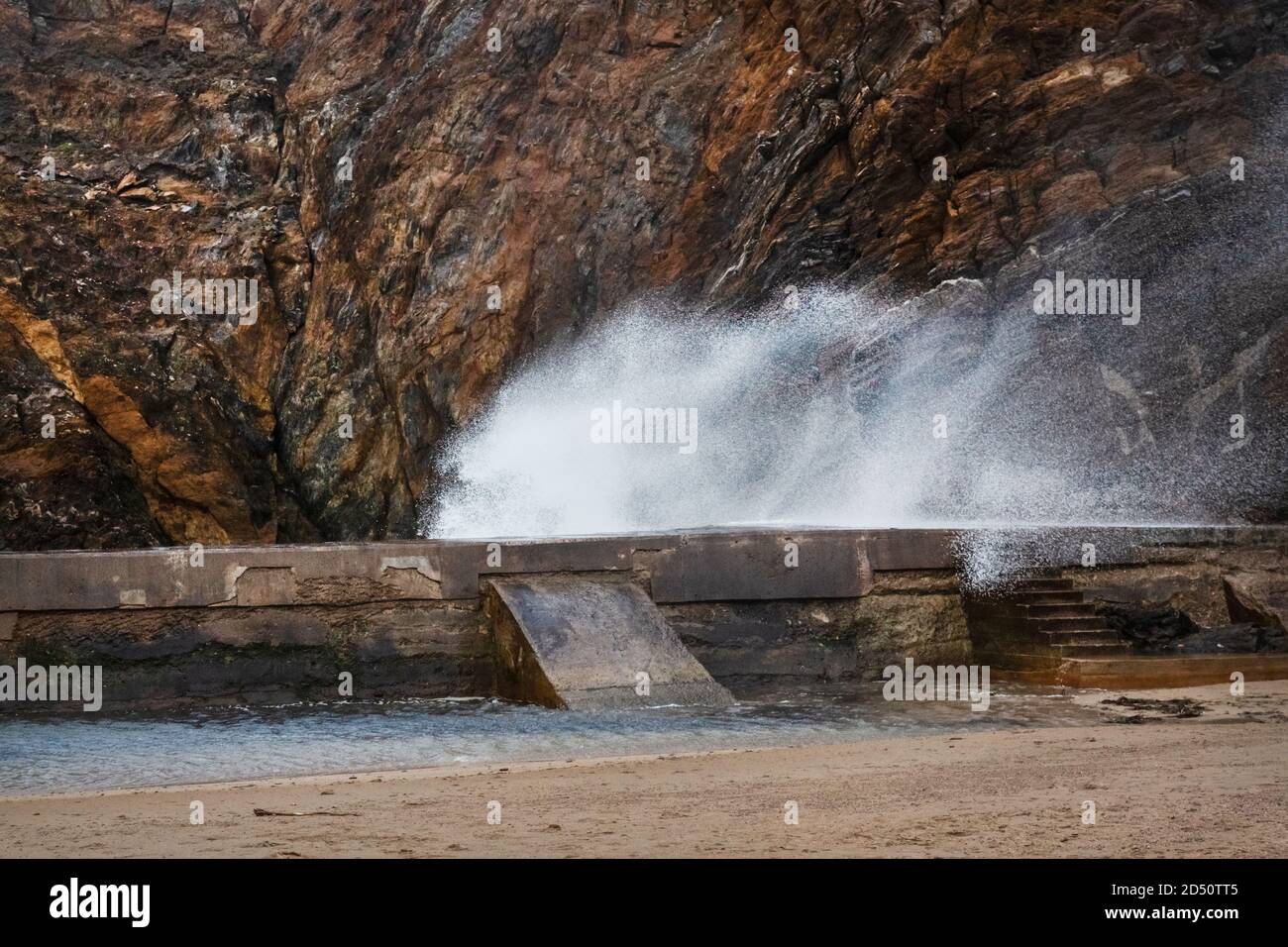 Waves crashing over wall sea defence Stock Photo - Alamy