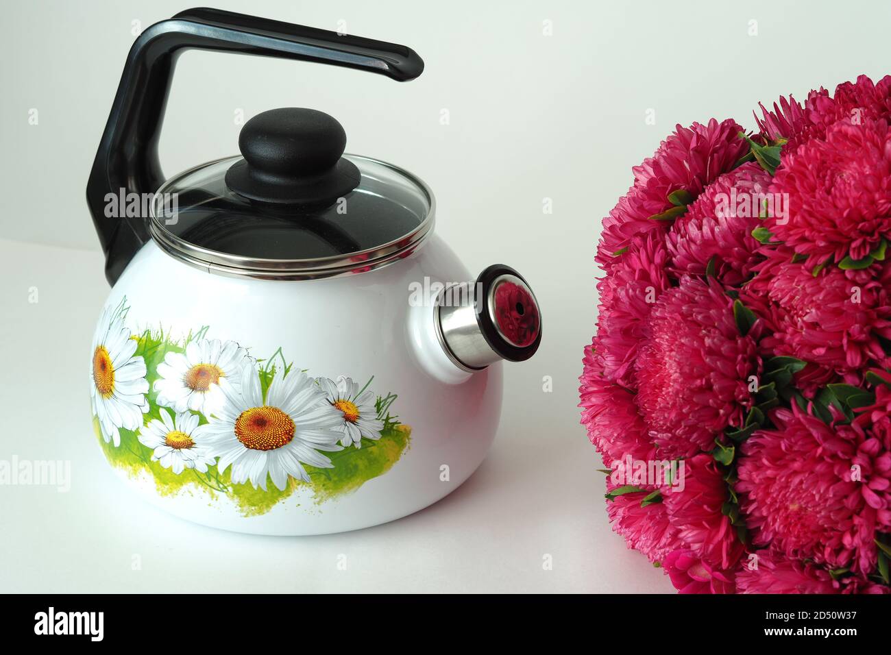 Enamelled utensils. Beautiful white enamelled kettle with whistle and ...