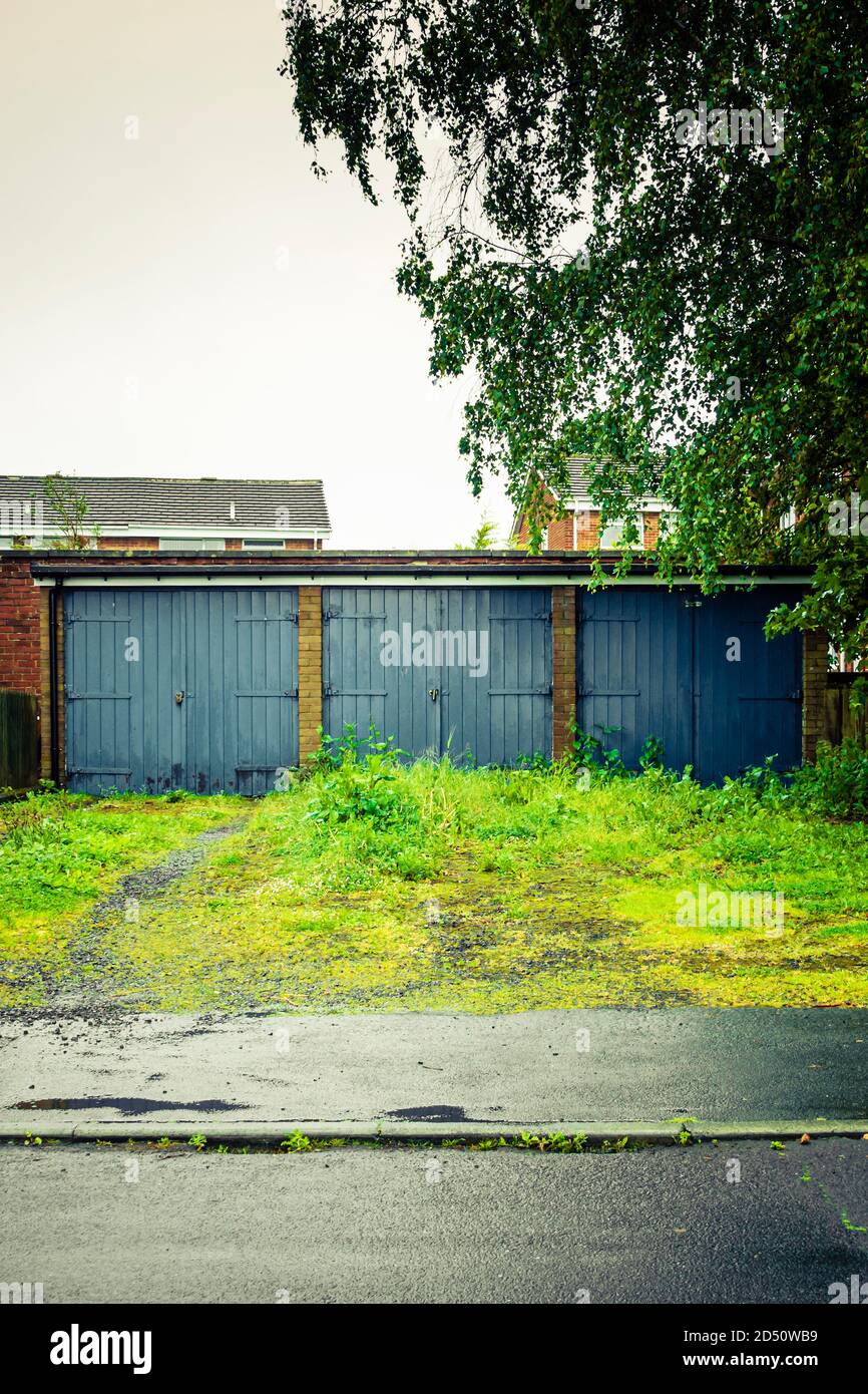 Three old run down garages with blue doors in Consett, County Durham ...