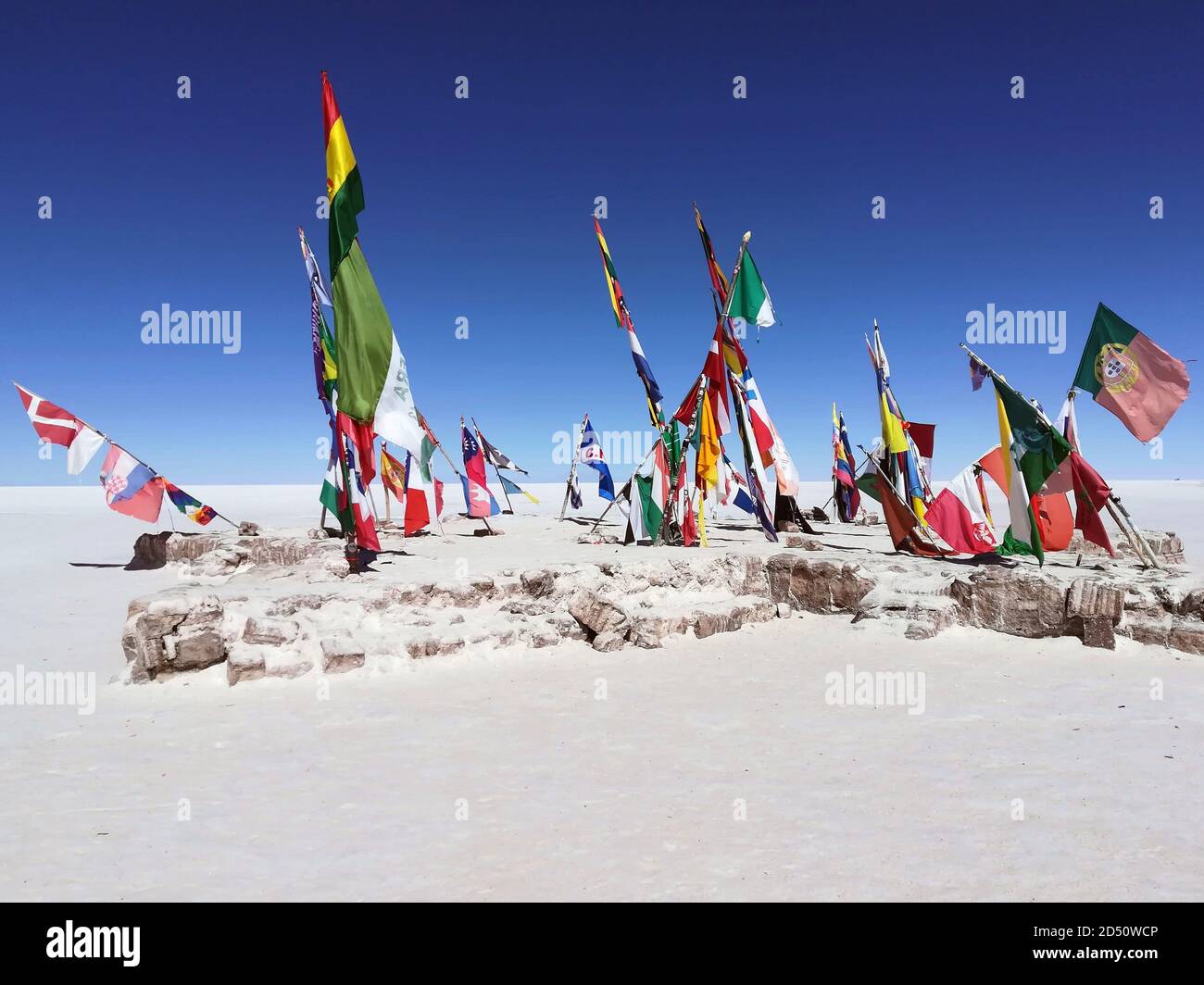 Beautiful shot of colorful flags in the summit of Salar de Uyuni in ...