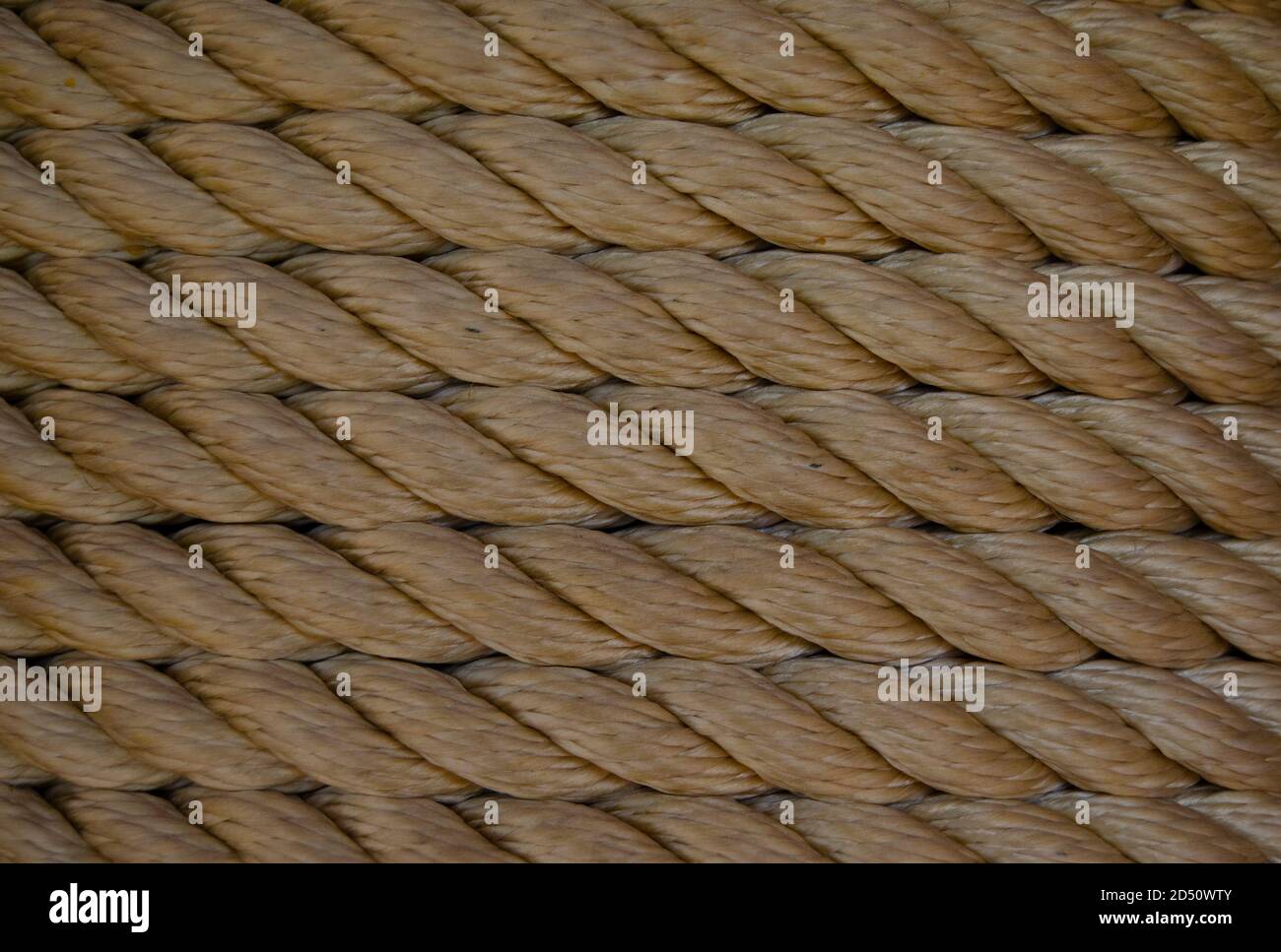 Thick rope wrapped around a pillar Stock Photo - Alamy