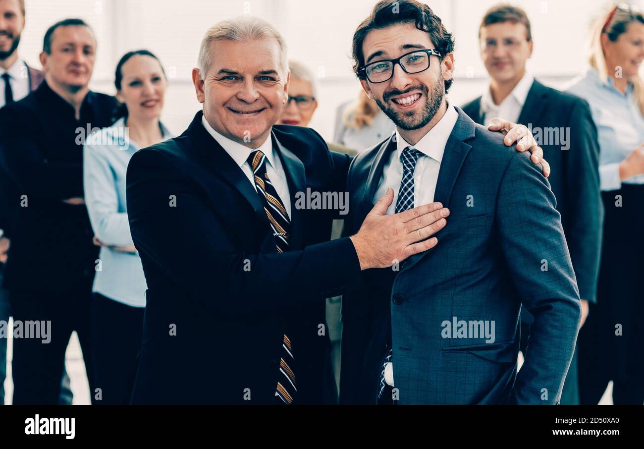 Manager congratulating the best employee at the meeting Stock Photo - Alamy