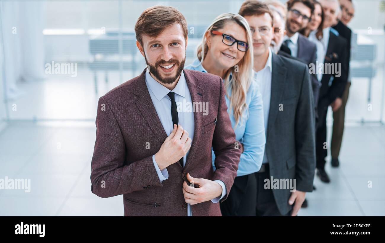 confident leader standing in front of the business team Stock Photo - Alamy