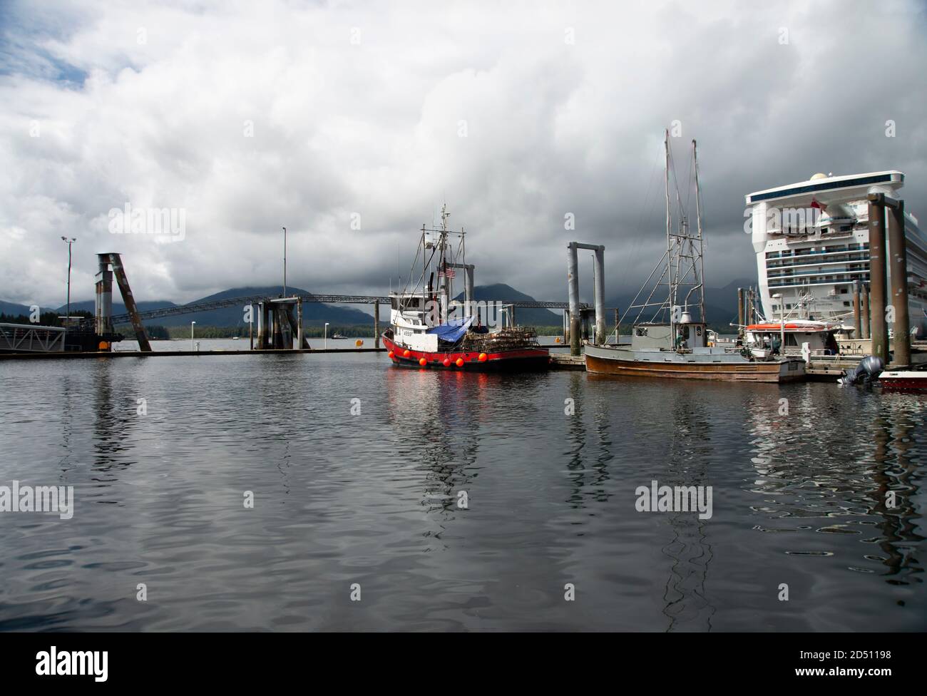 Harbor in Alaska with huge cruise ships, and small vessels docked Stock ...