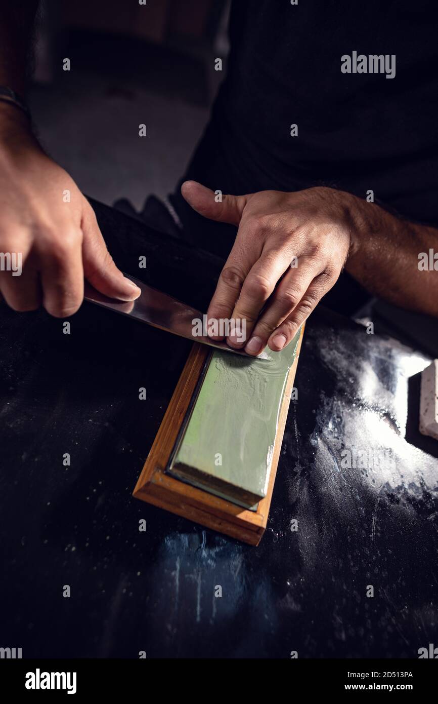 The man using whetstone Stock Photo - Alamy
