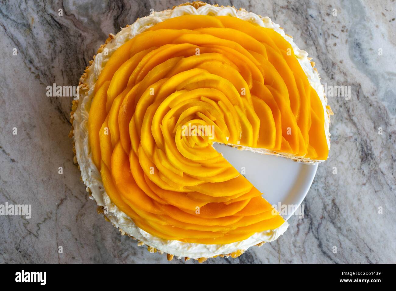 Delicious baked mango cake with nuts Stock Photo - Alamy