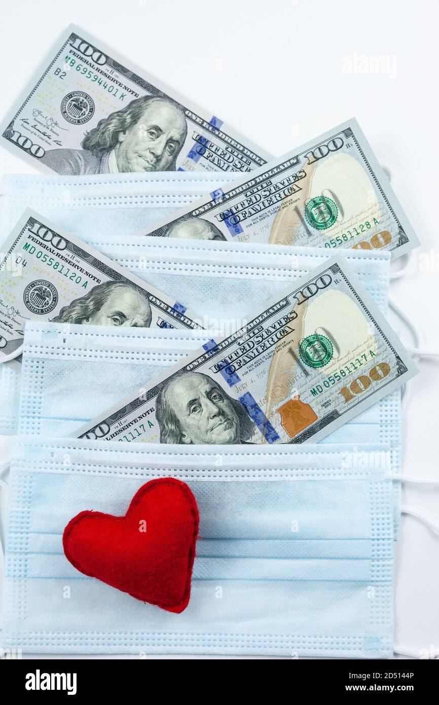 Red heart,medical masks and dollars.Helping poor countries with money ...