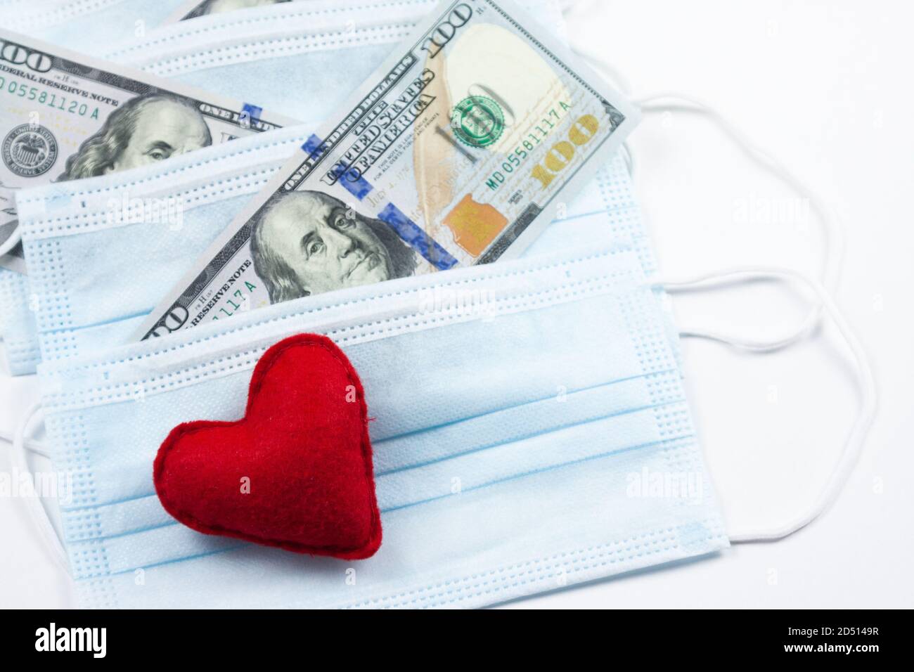Red heart,medical masks and dollars.Helping poor countries with money ...