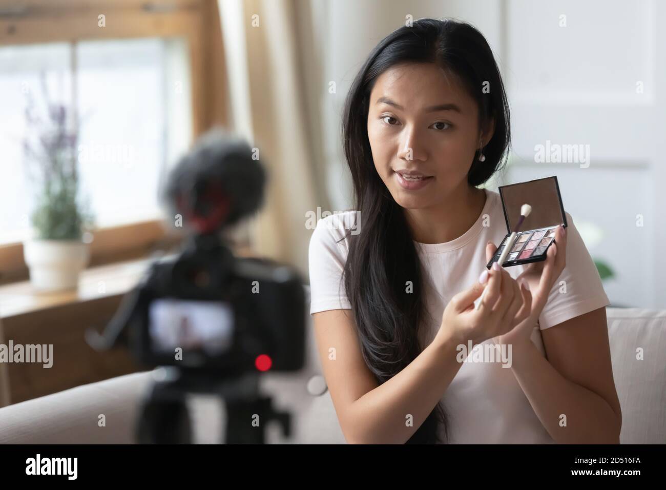 Close up young Asian woman vlogger shooting cosmetics review video ...