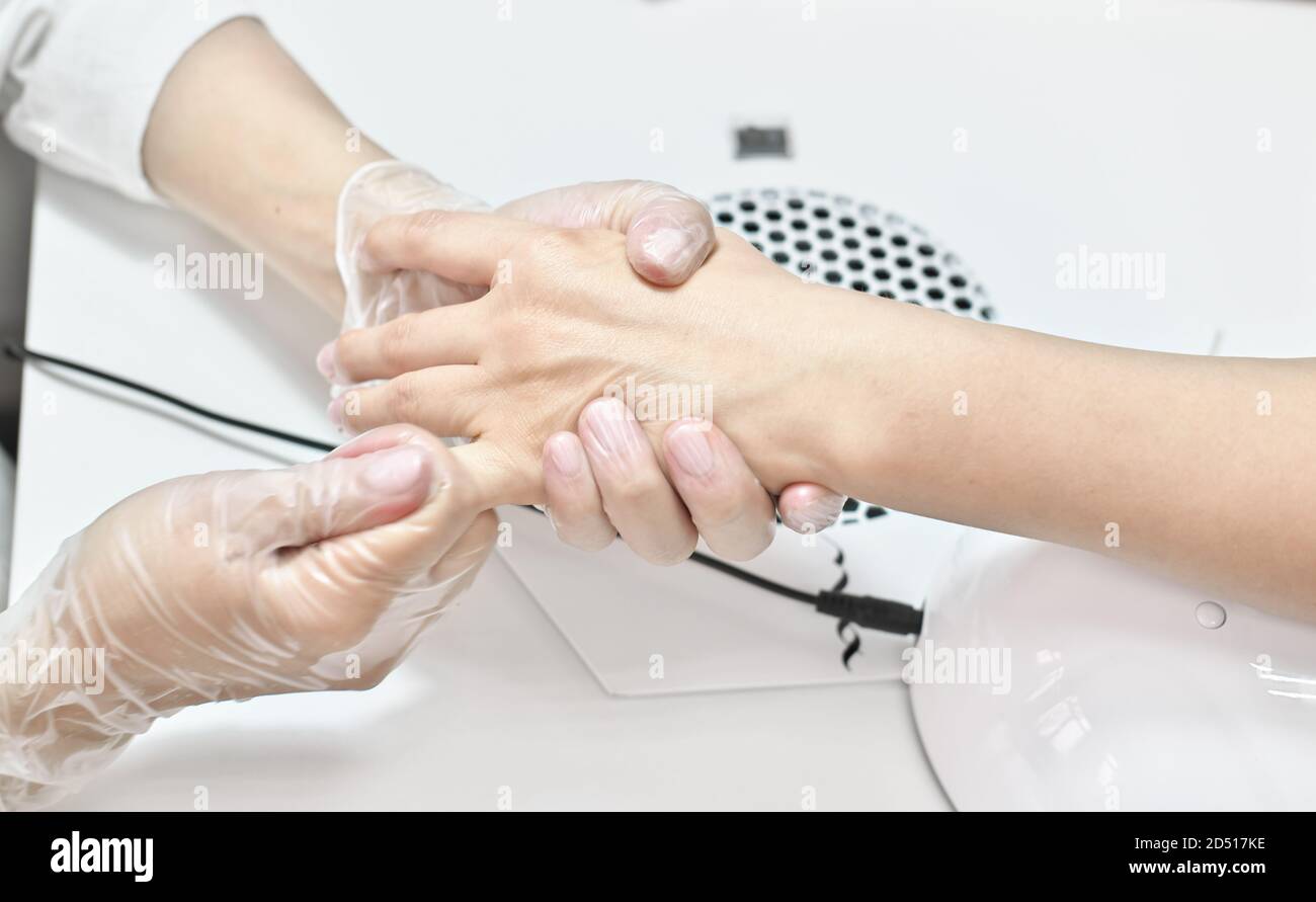 woman getting hand massage in beauty salon. client and beautician ...