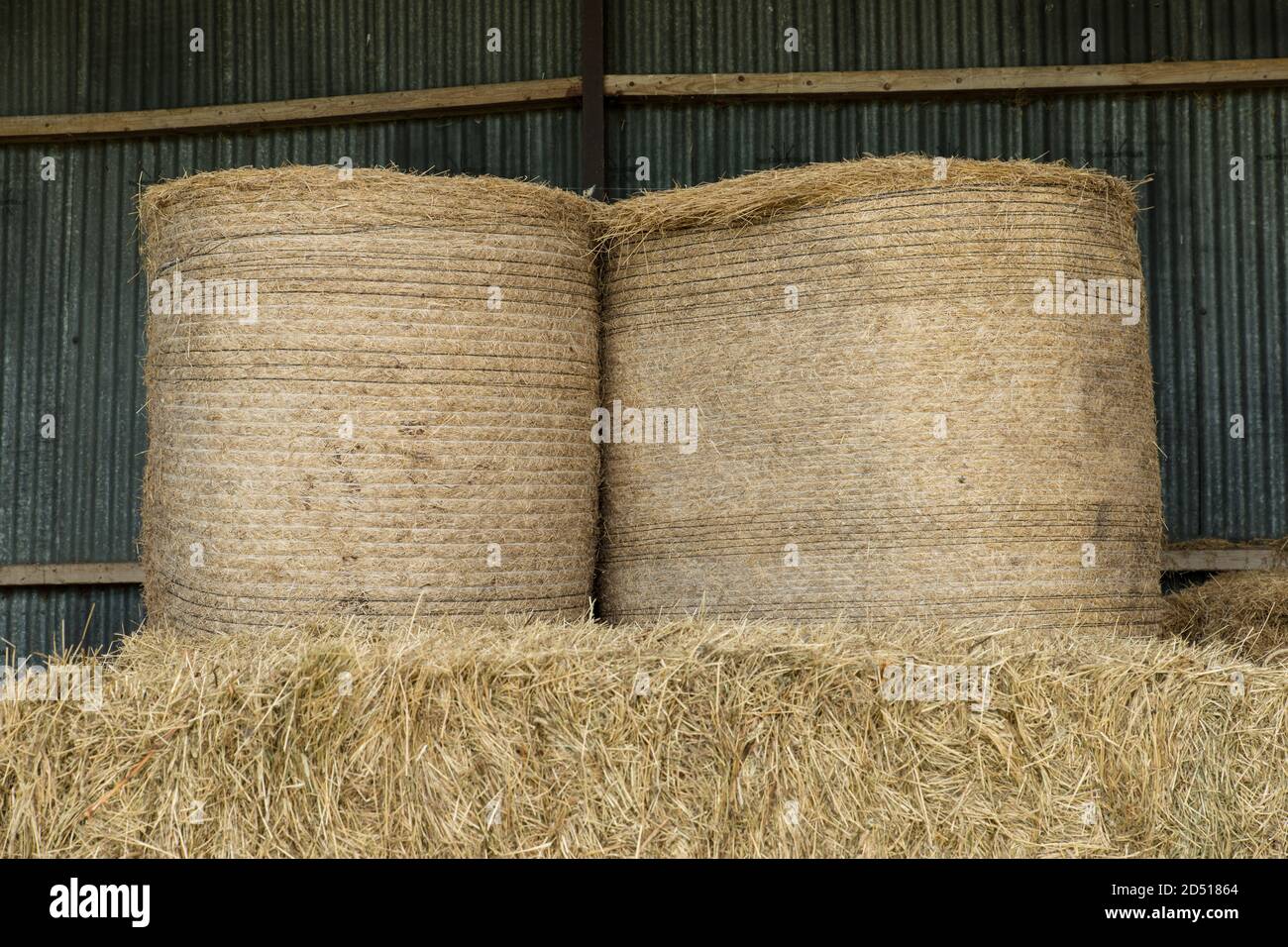 close up of different shaped hay-bales for food store inside barn in ...