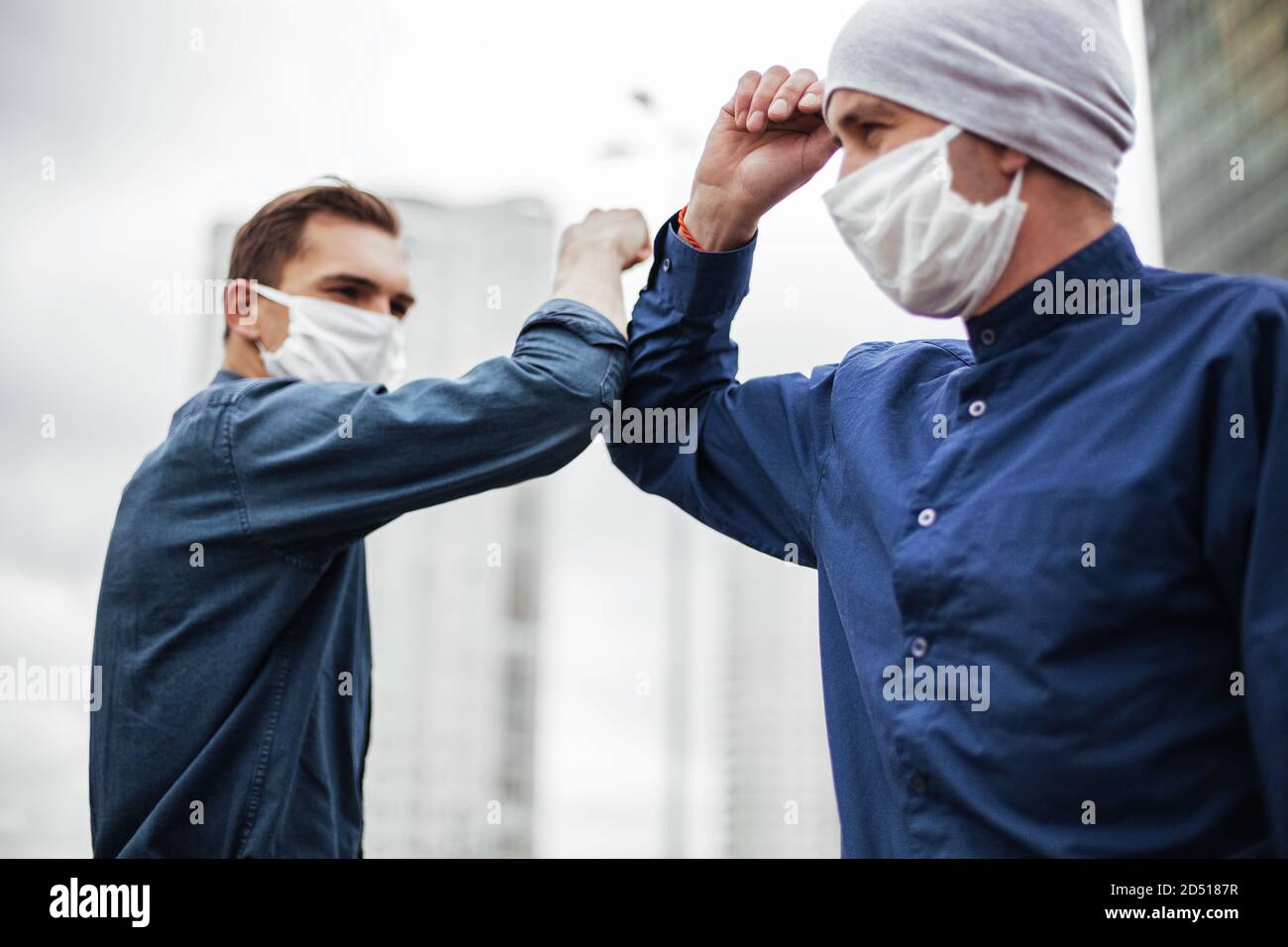 close up. two young men greeting each other with their elbows Stock ...