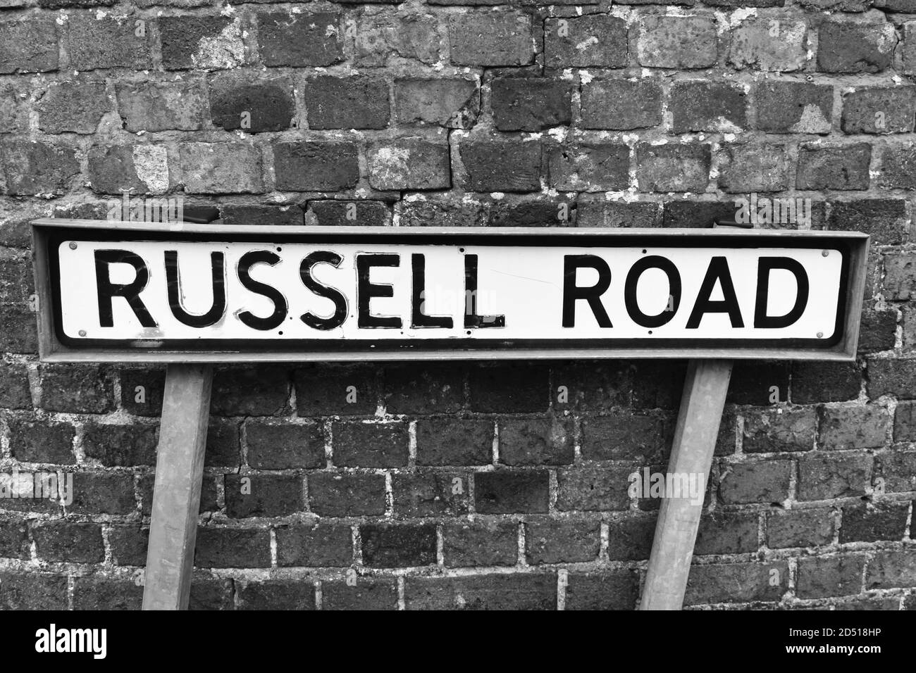 close up black and white image of Russell Road road sign black text on ...