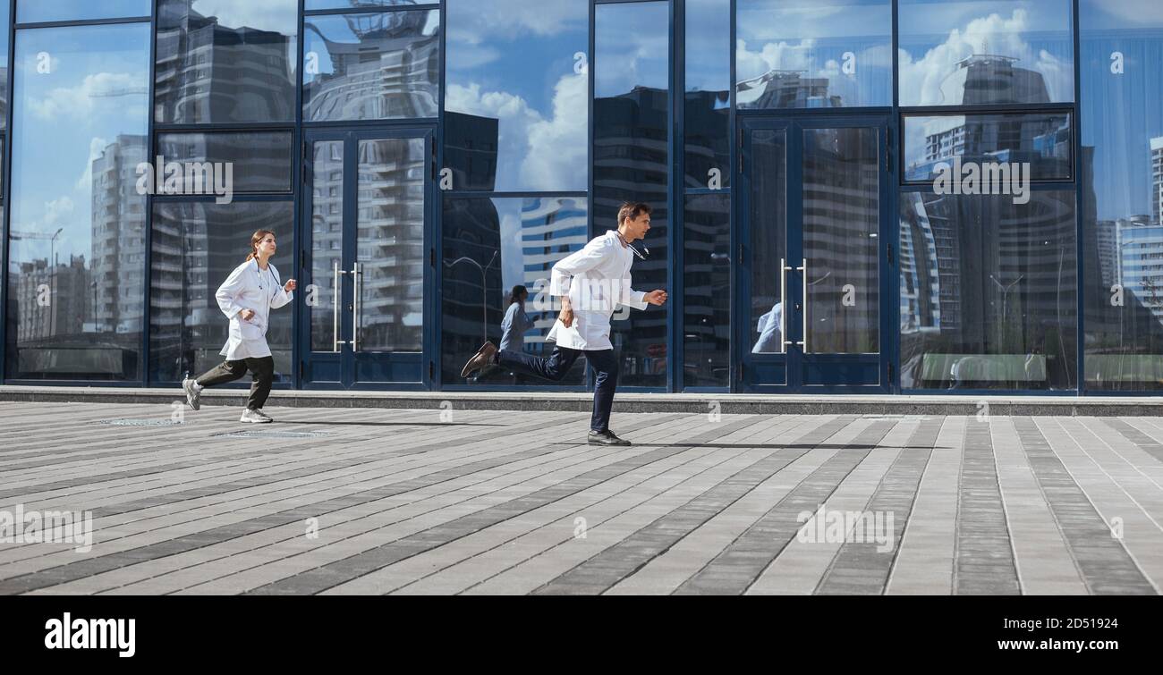 in full growth. running doctors on a city street Stock Photo - Alamy