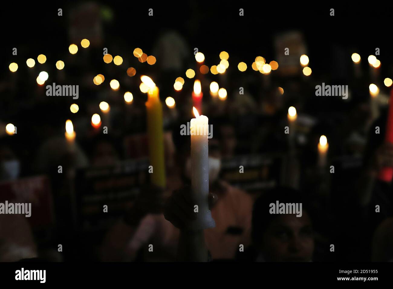 Activists hold lit candles during the demonstration.Activists of Indian ...