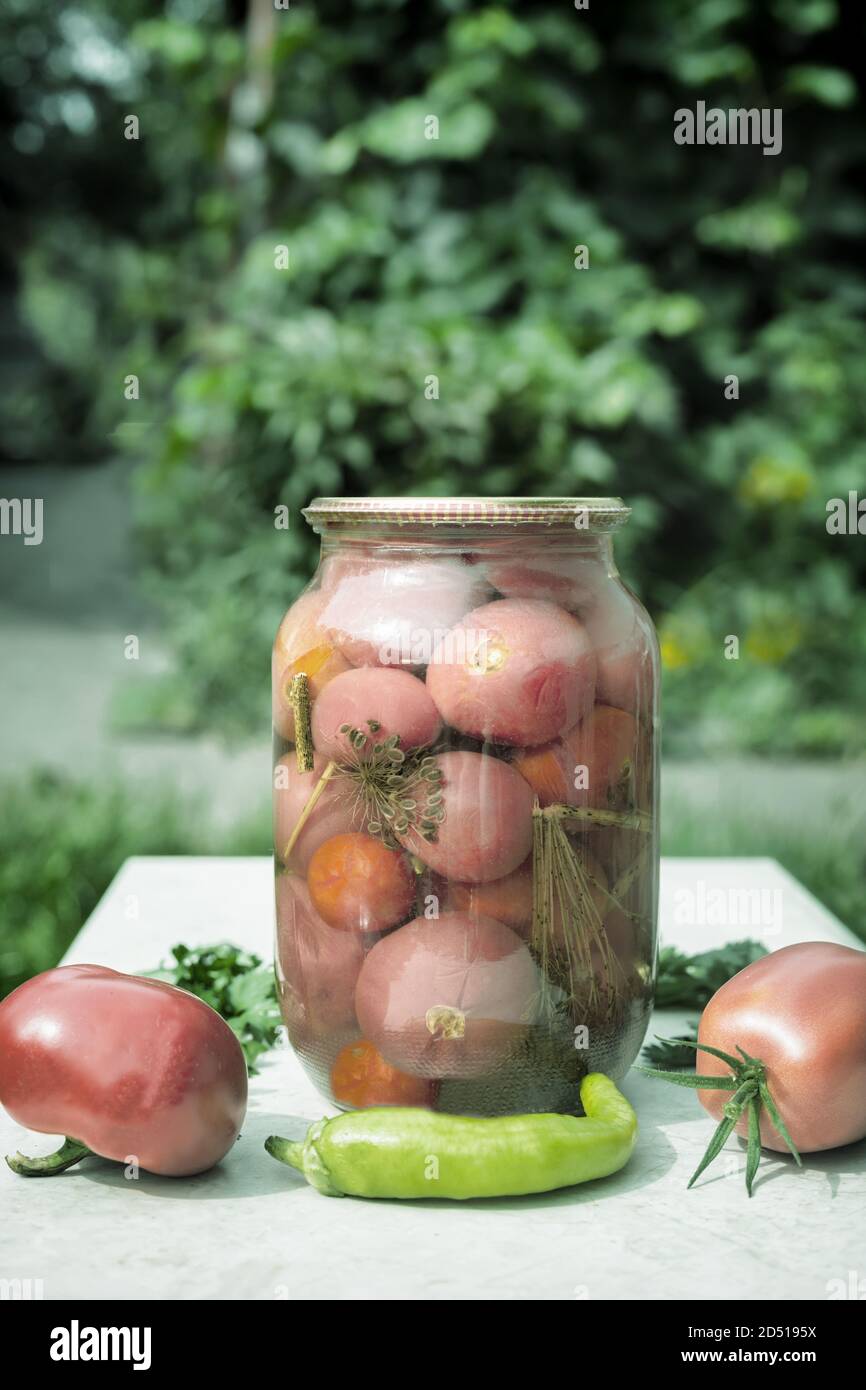 Canned tomatoes in a large glass jar Stock Photo - Alamy