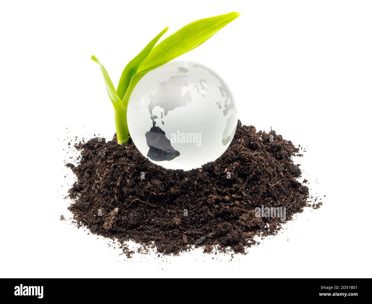 Globe with seedling and pile of earth Stock Photo - Alamy