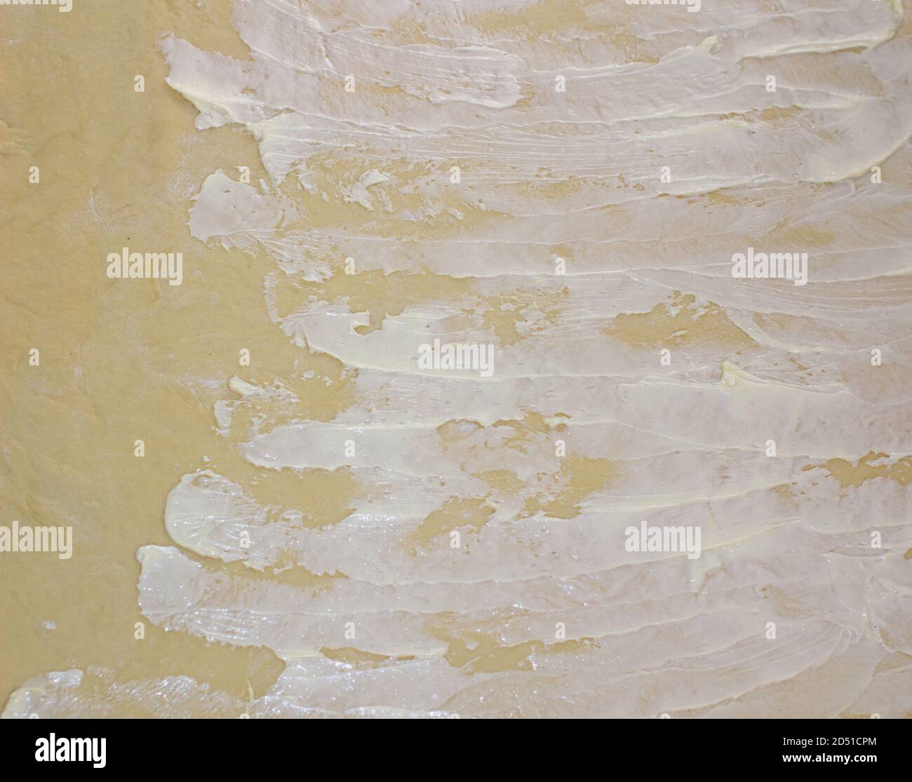 Rolled out and spread with butter and butter for baking Stock Photo - Alamy