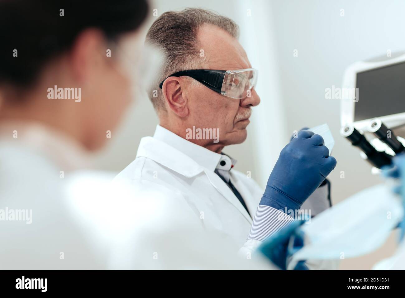 scientists putting on a protective mask in a medical laboratory Stock ...