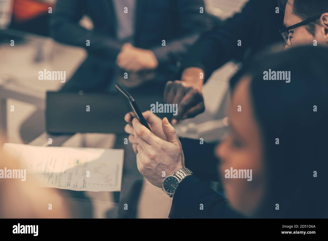 close up. employees using their smartphone to view new information ...
