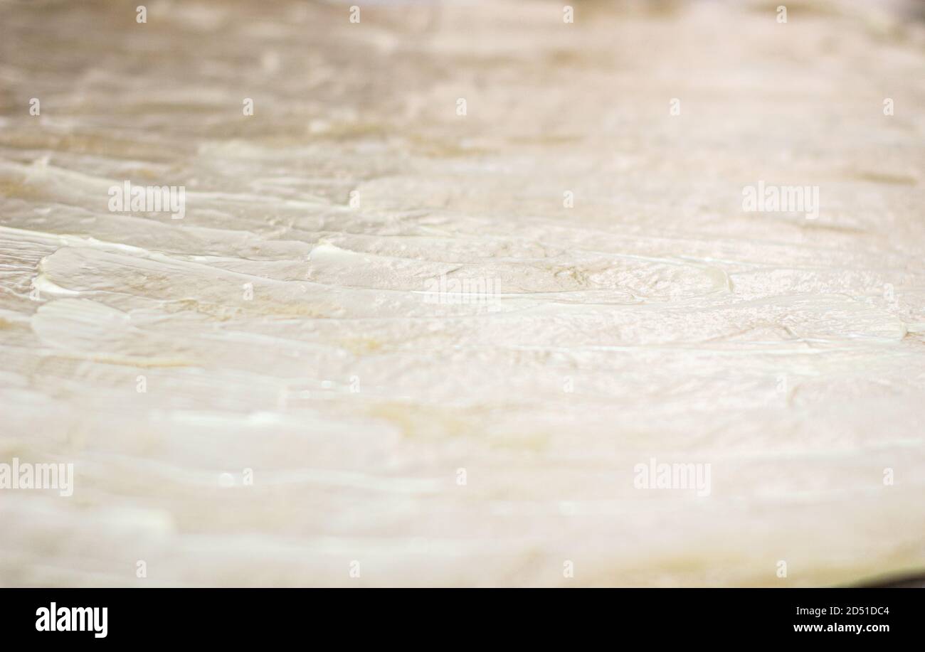 Rolled out and spread with butter and butter for baking Stock Photo - Alamy