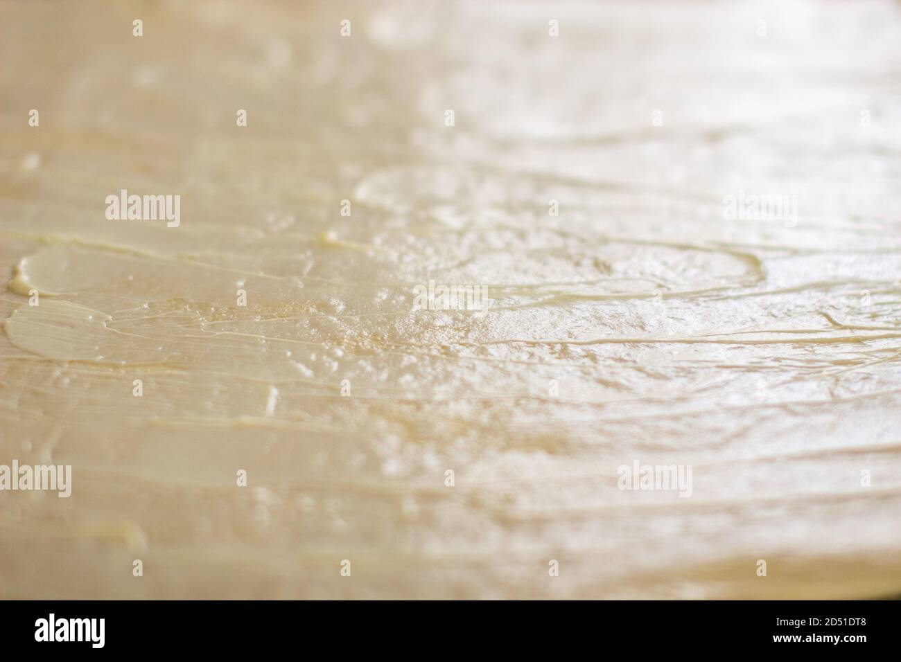 Rolled out and spread with butter and butter for baking Stock Photo - Alamy