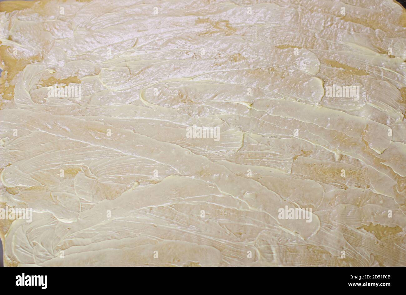 Rolled out and spread with butter and butter for baking Stock Photo - Alamy