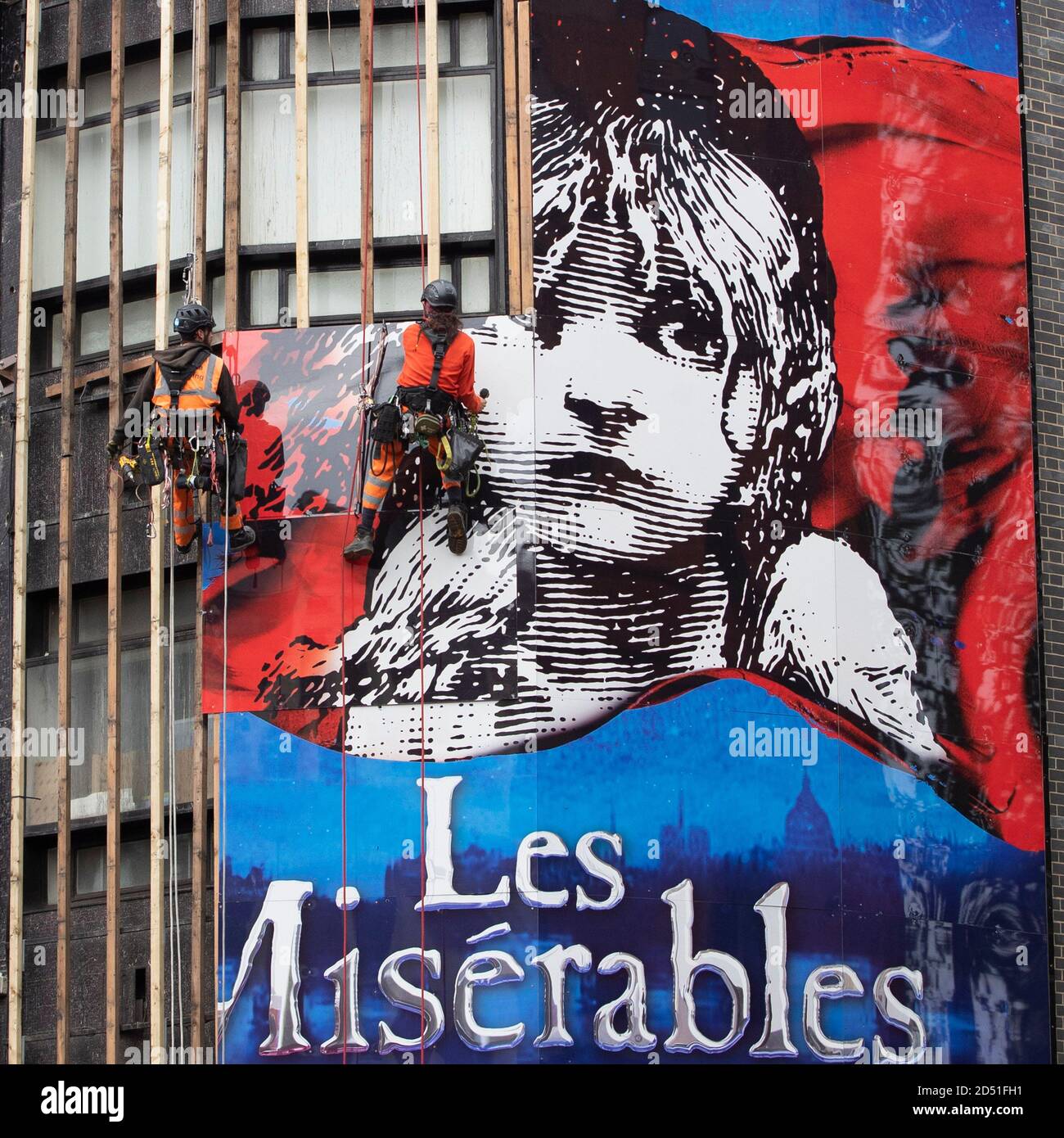 Workmen remove signs from London’s Sondheim Theatre’s Les Miserables ...
