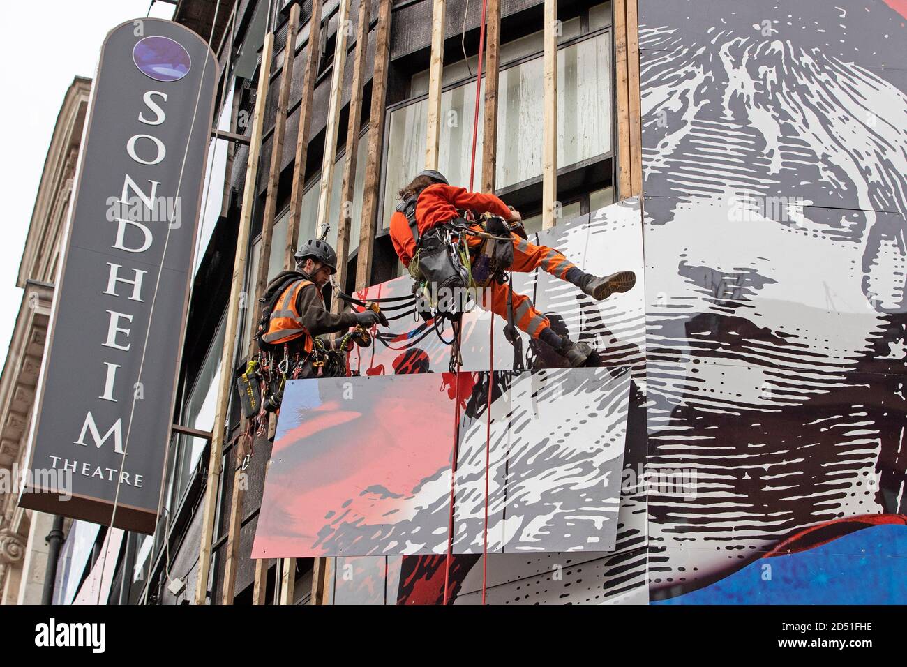Workmen remove signs from London’s Sondheim Theatre’s Les Miserables ...