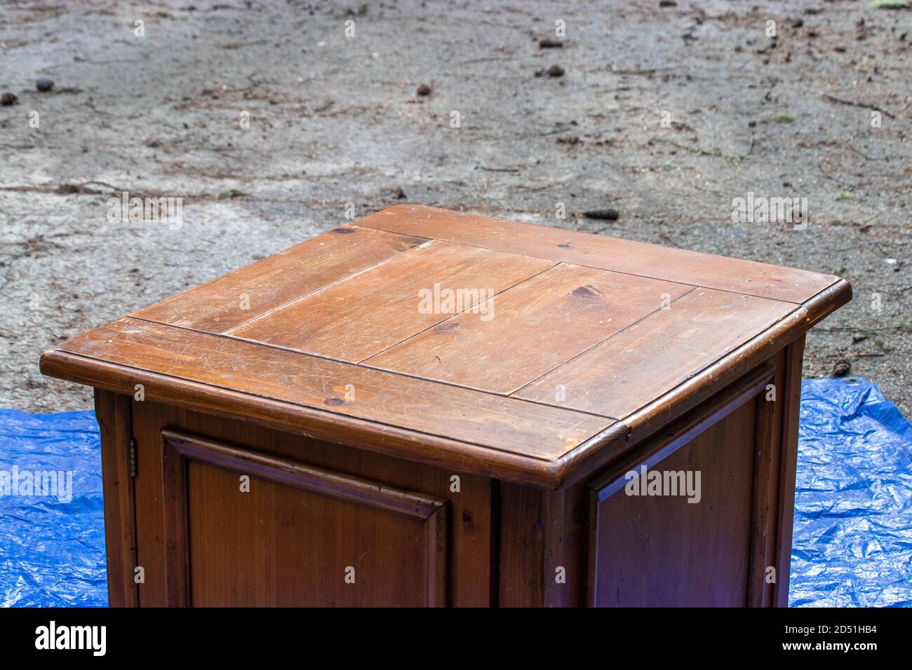 old antique side table set out on a blue tarp being refinished Stock ...
