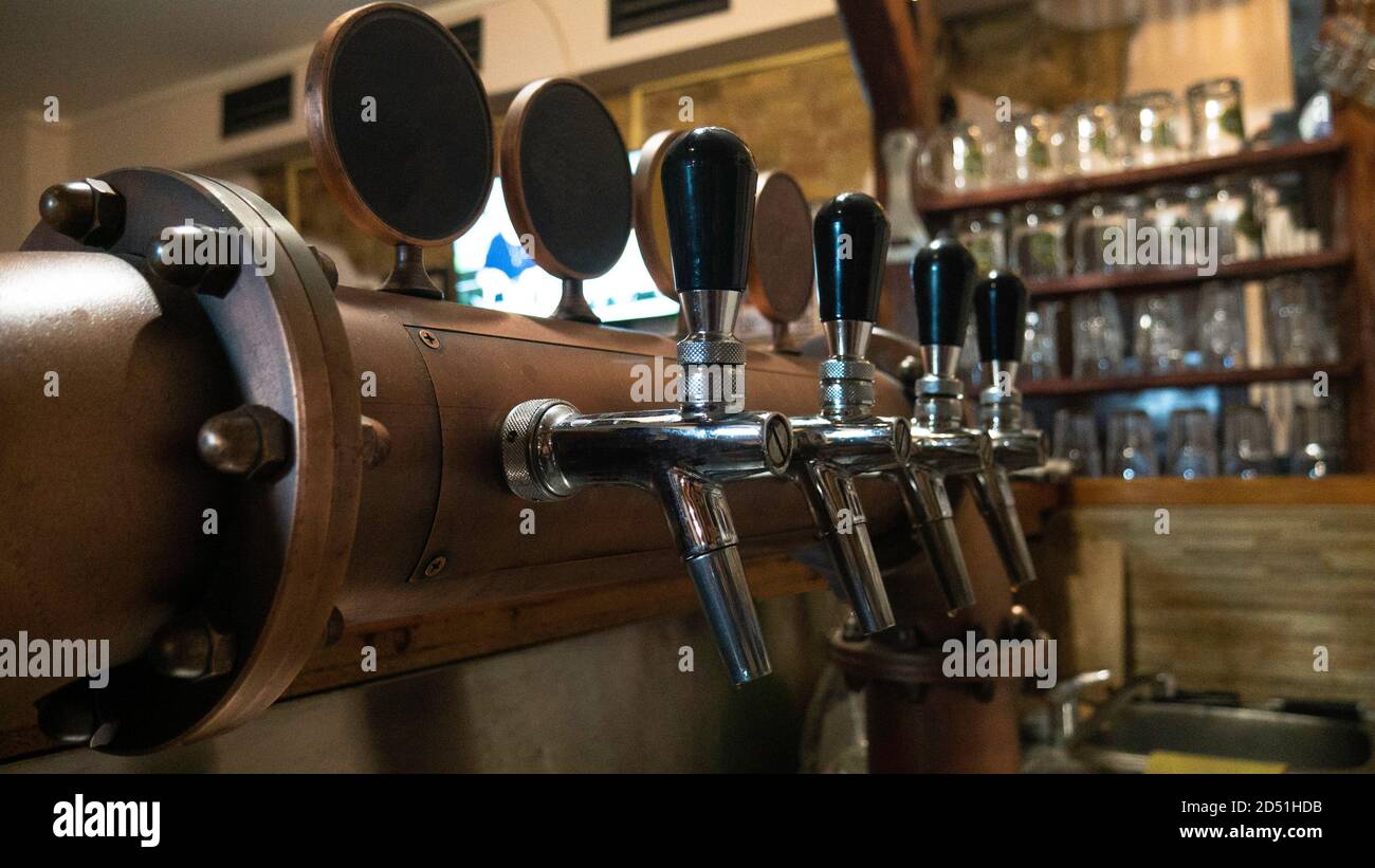 The beer taps in a pub Stock Photo - Alamy